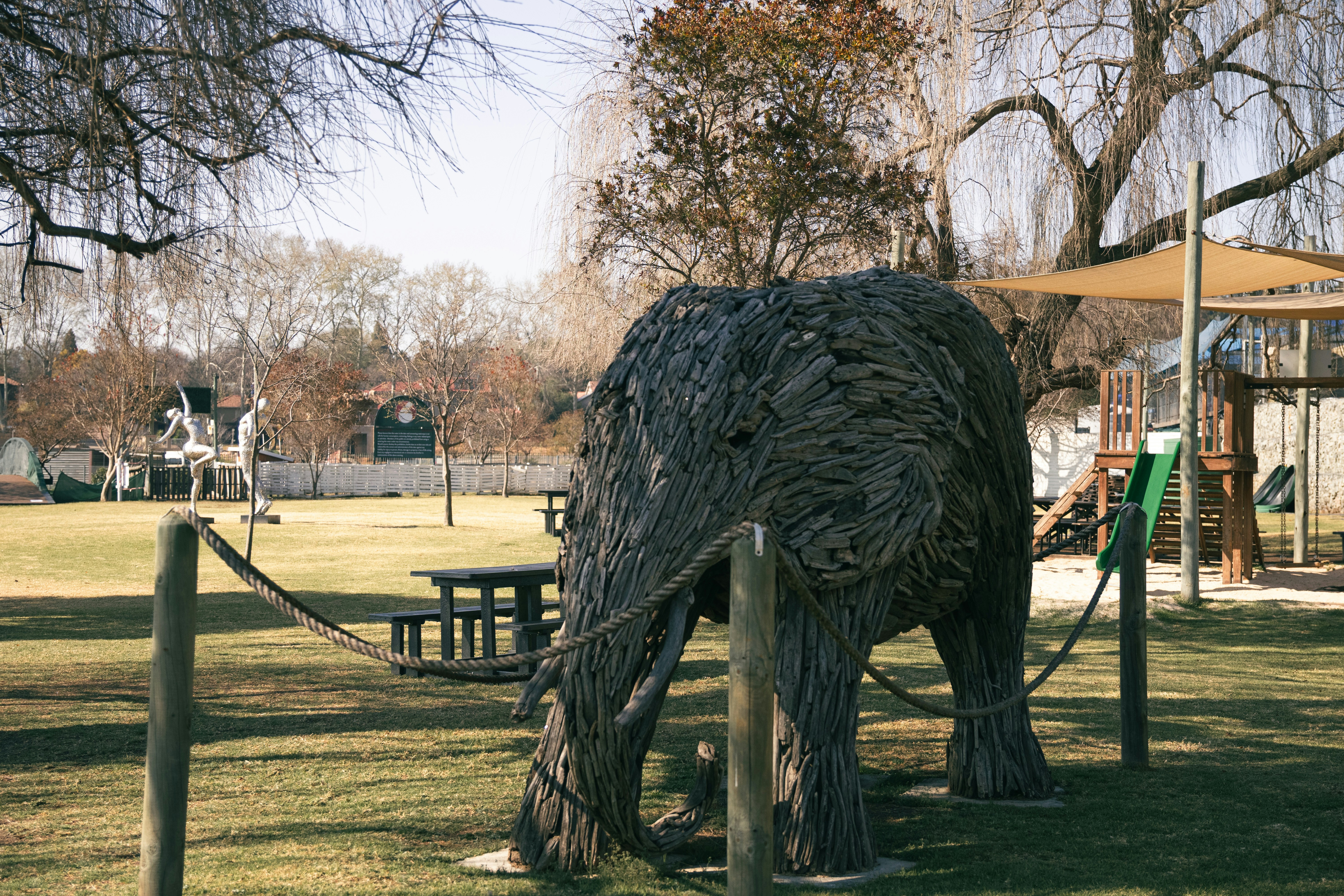 Iron Sentinel: A Grazing Iron Elephant Guards the Park