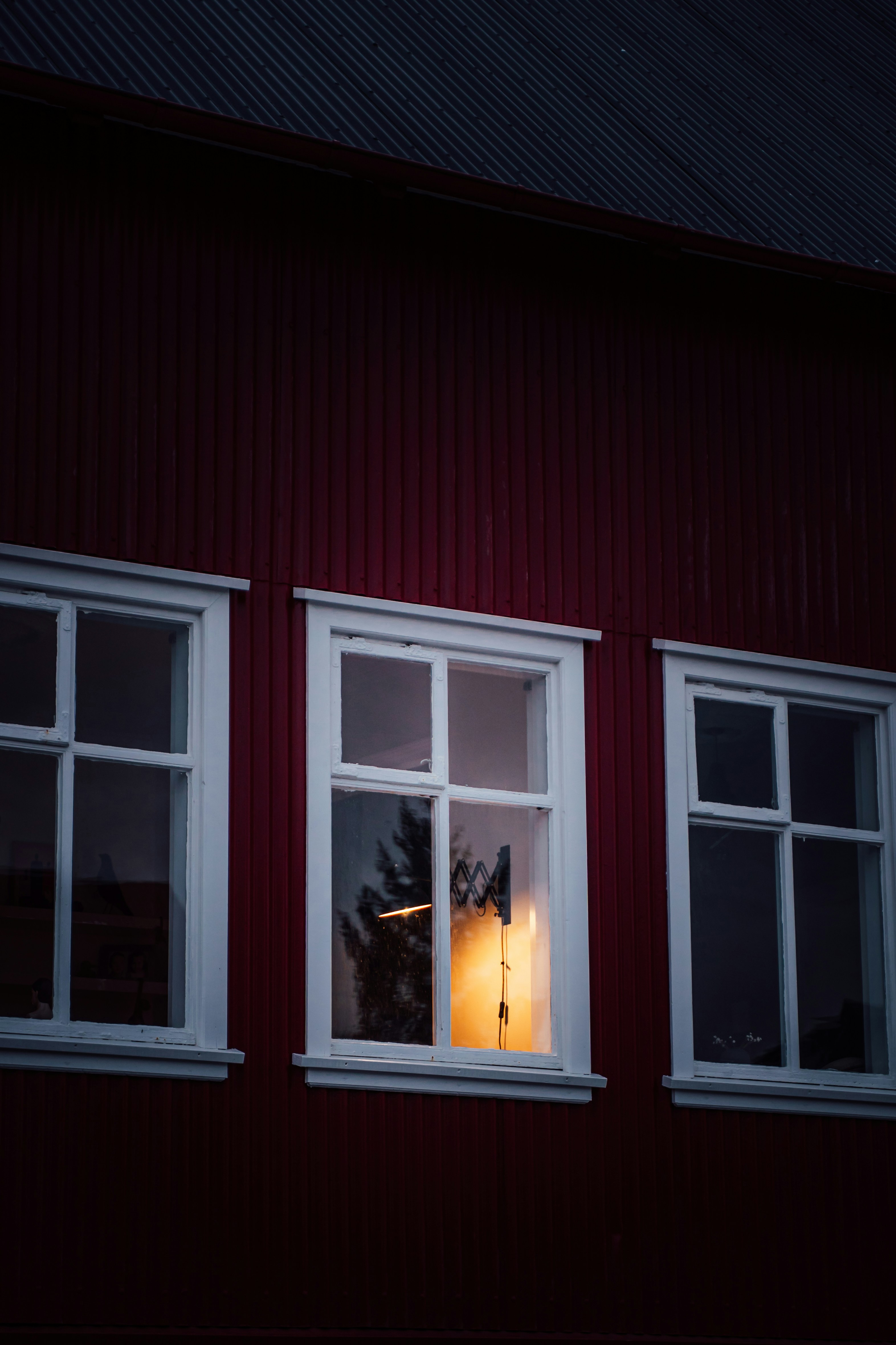 Warm Window Glow in a Deep Red House