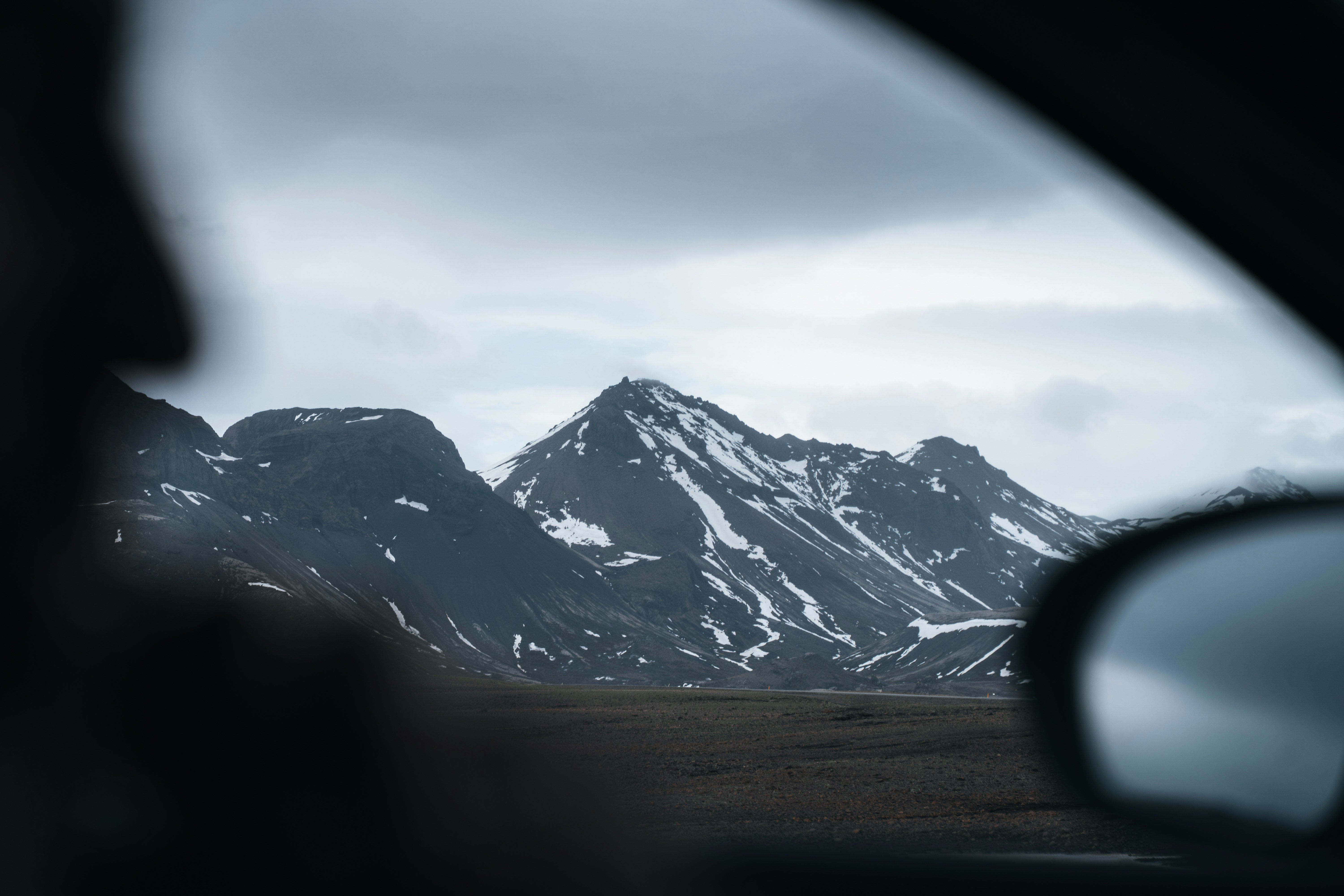 Snowy Peaks Through a Car Window