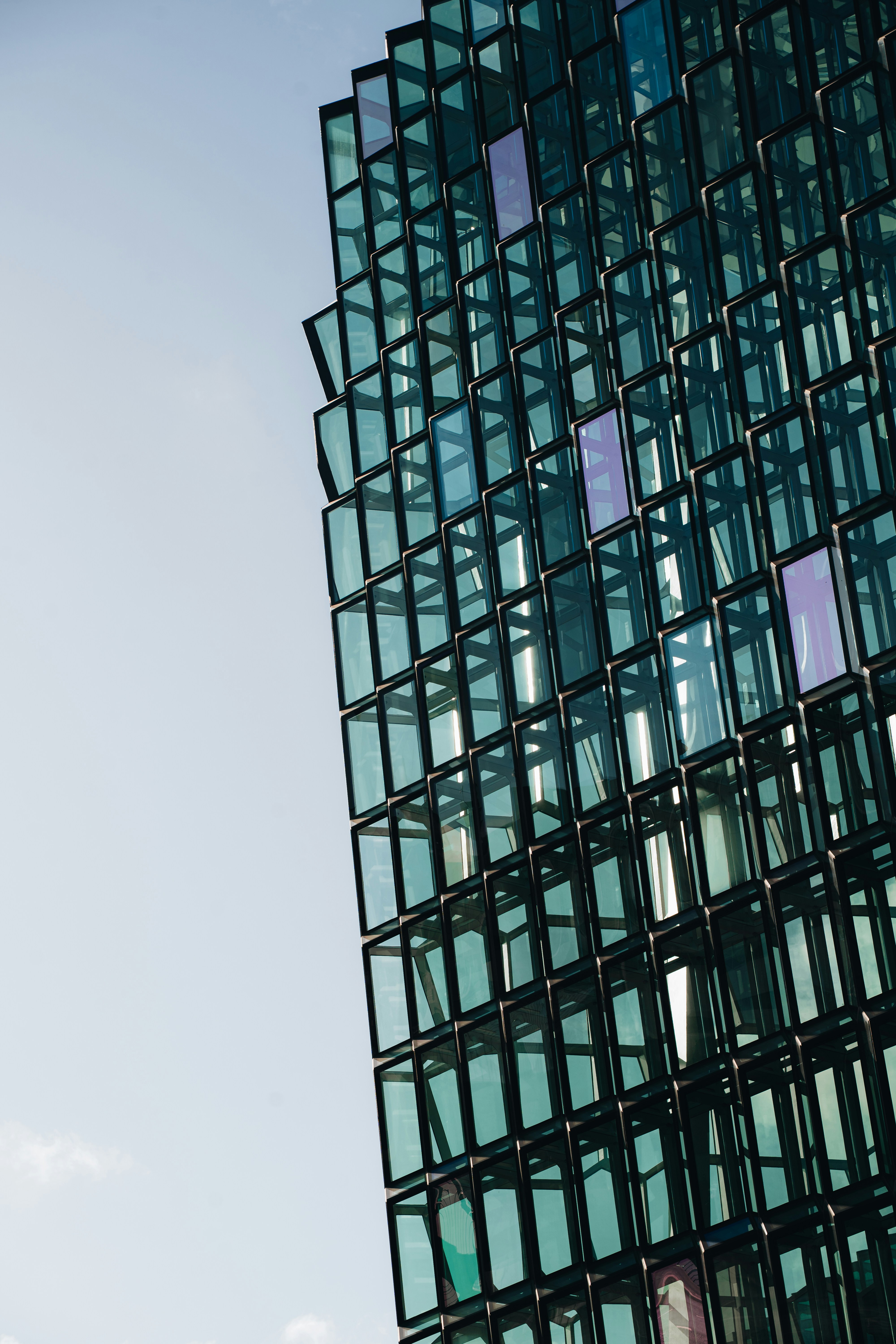 Glassy Facade Portrait: a diagonal grid of colored panes catching the daylight