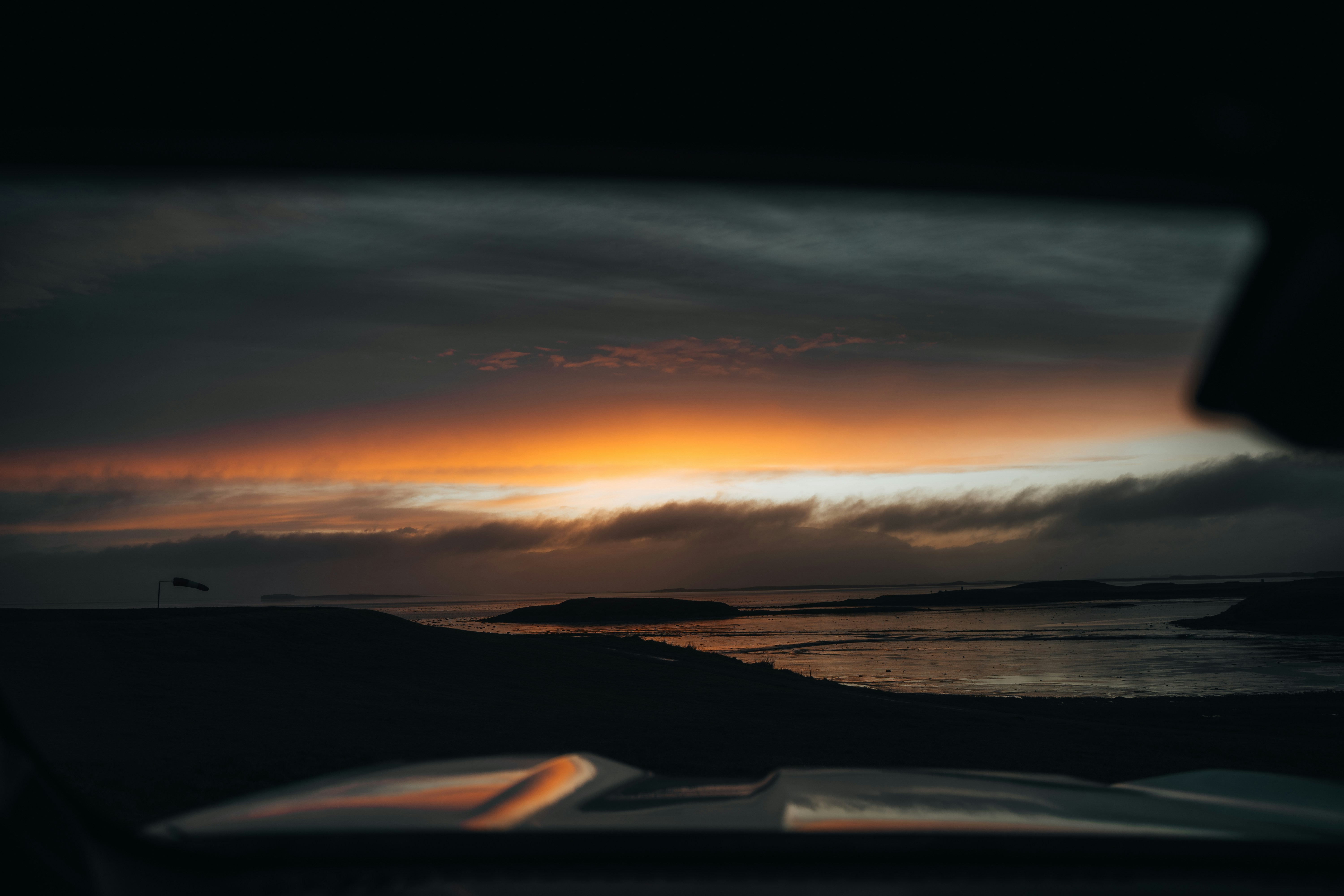 Sunset Confluence: A Quiet Horizon Framed by Car’s Interior