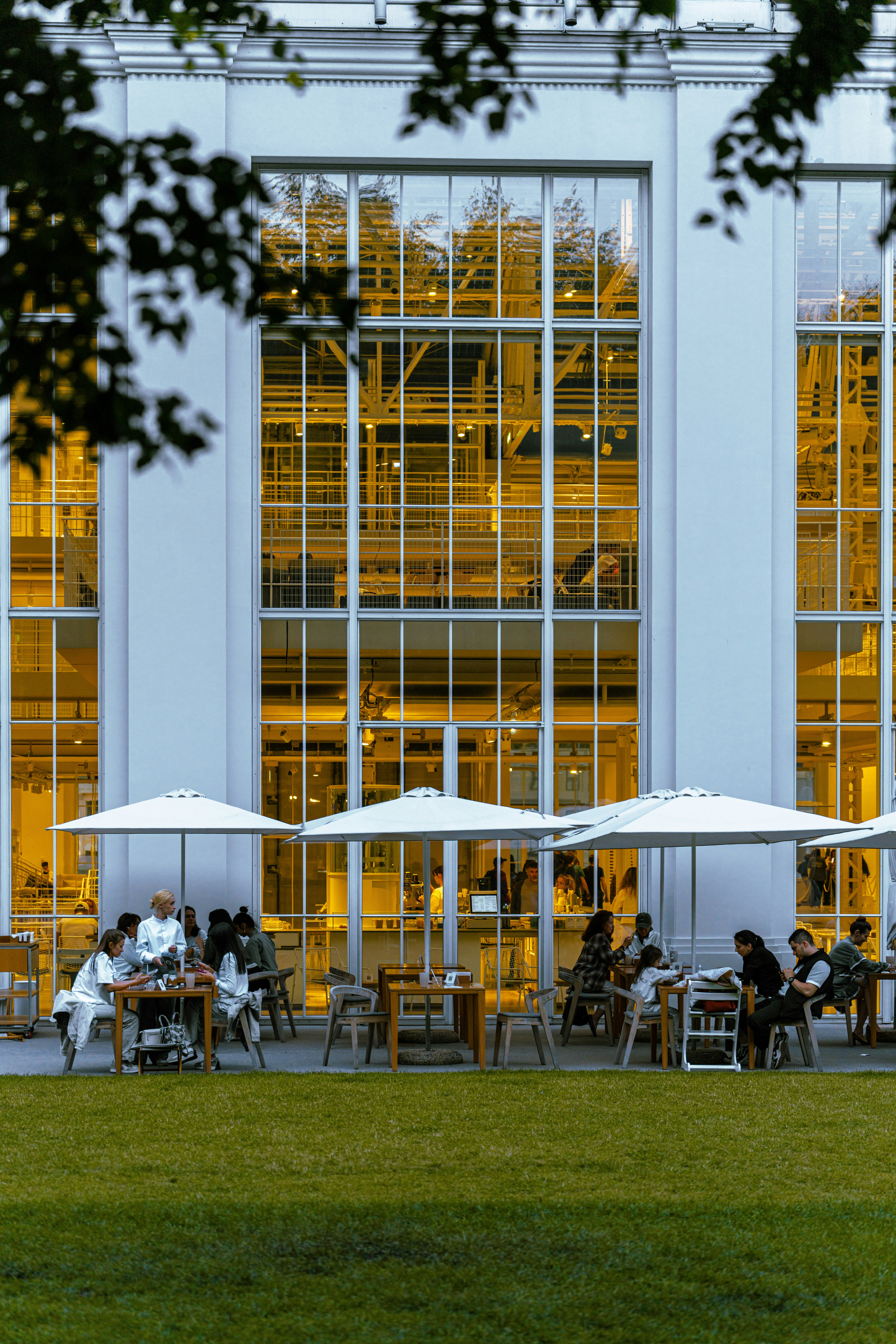 Glasshouse Café Reds: Evening Light Through Alloy and Umbrellas
