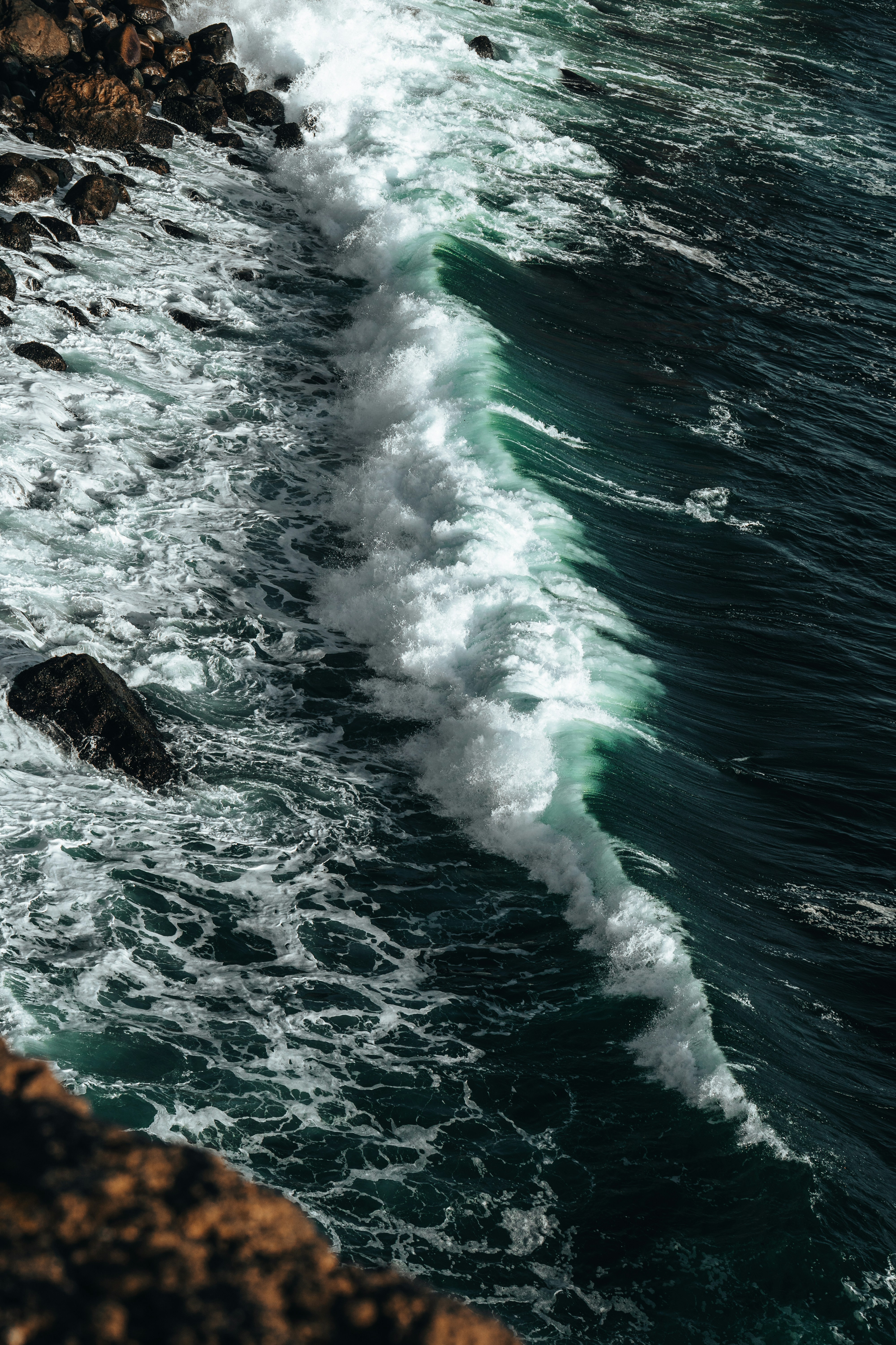 Cresting Green: A Wave’s Edge Against rugged shore