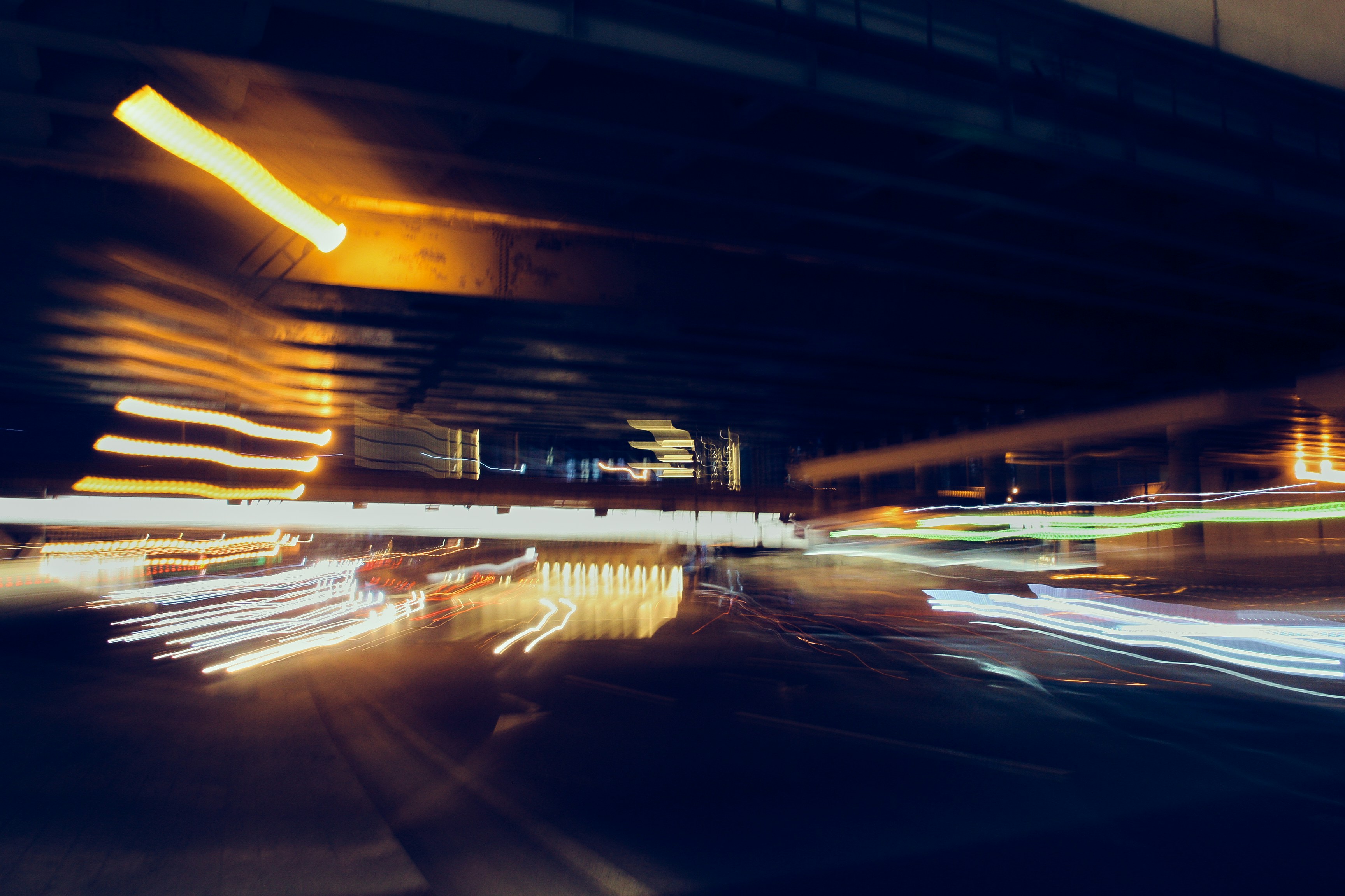 Blurred Motion Overpass: Neon Arcs in Night Traffic