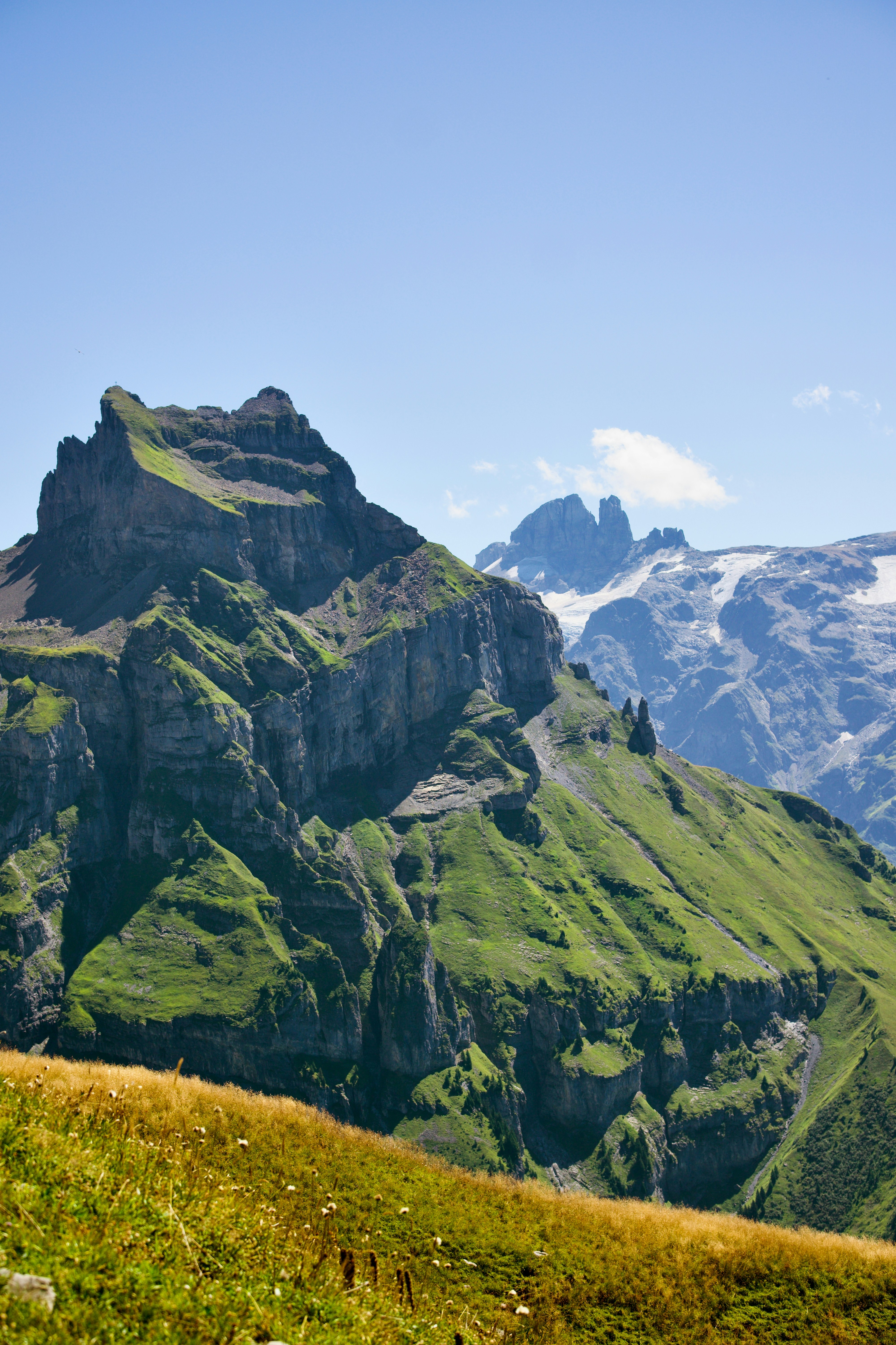 Stone Crown: A Valley of Green Ridges Beneath Alpine Peaks
