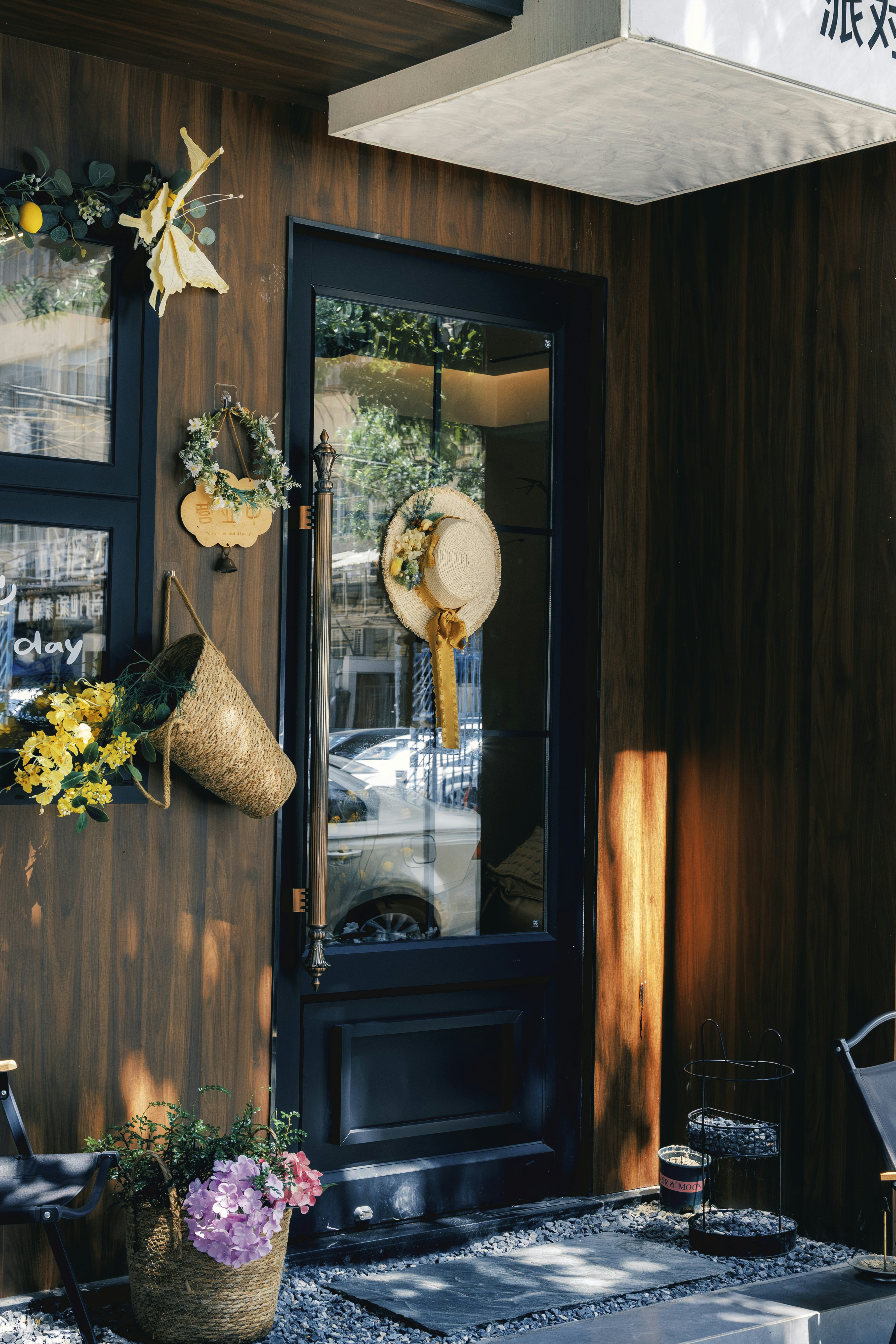 Wooden door with sunlit decor and straw hat centerpiece