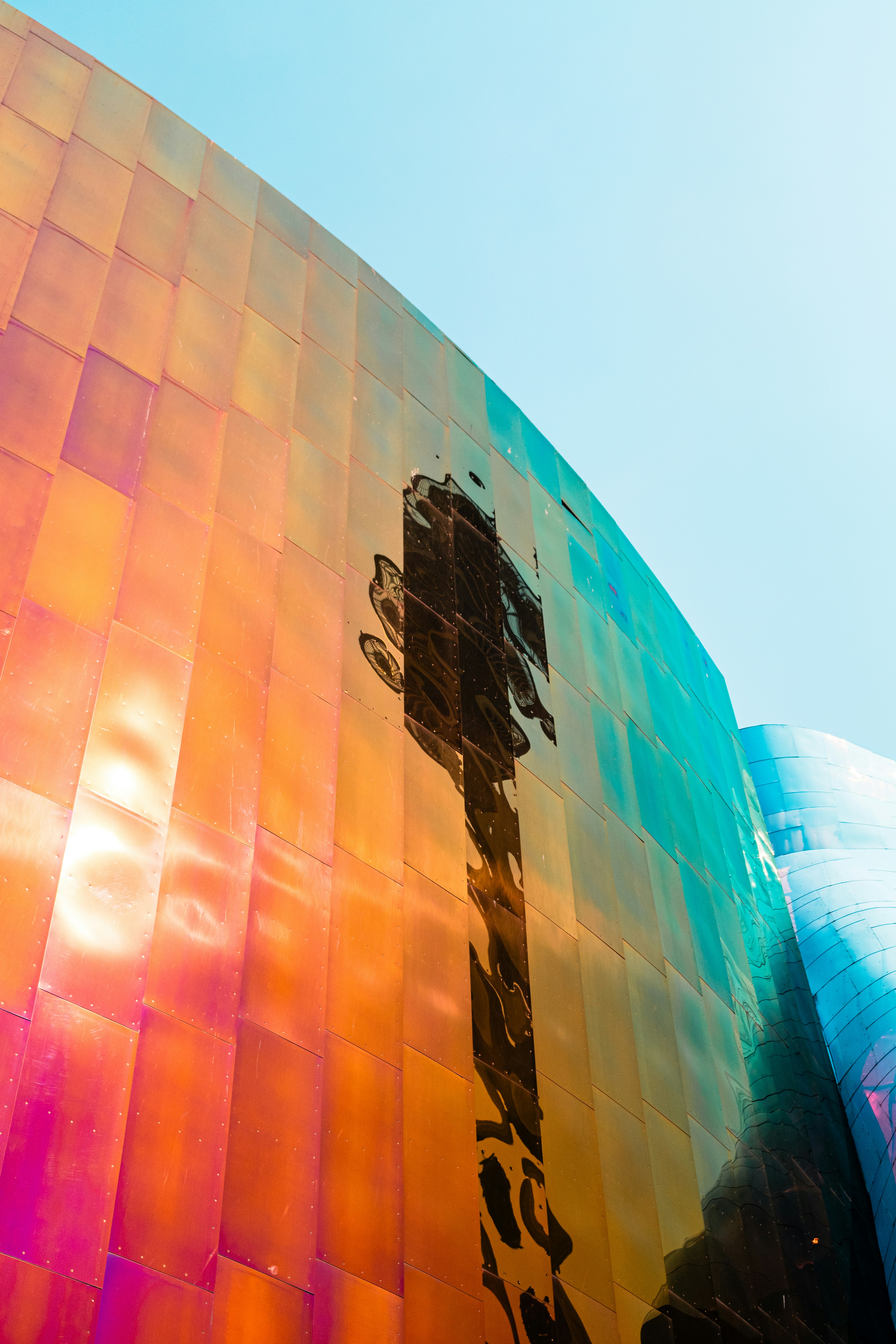 Chromatic Facade: Sunset Hues on a Shimmering Curve