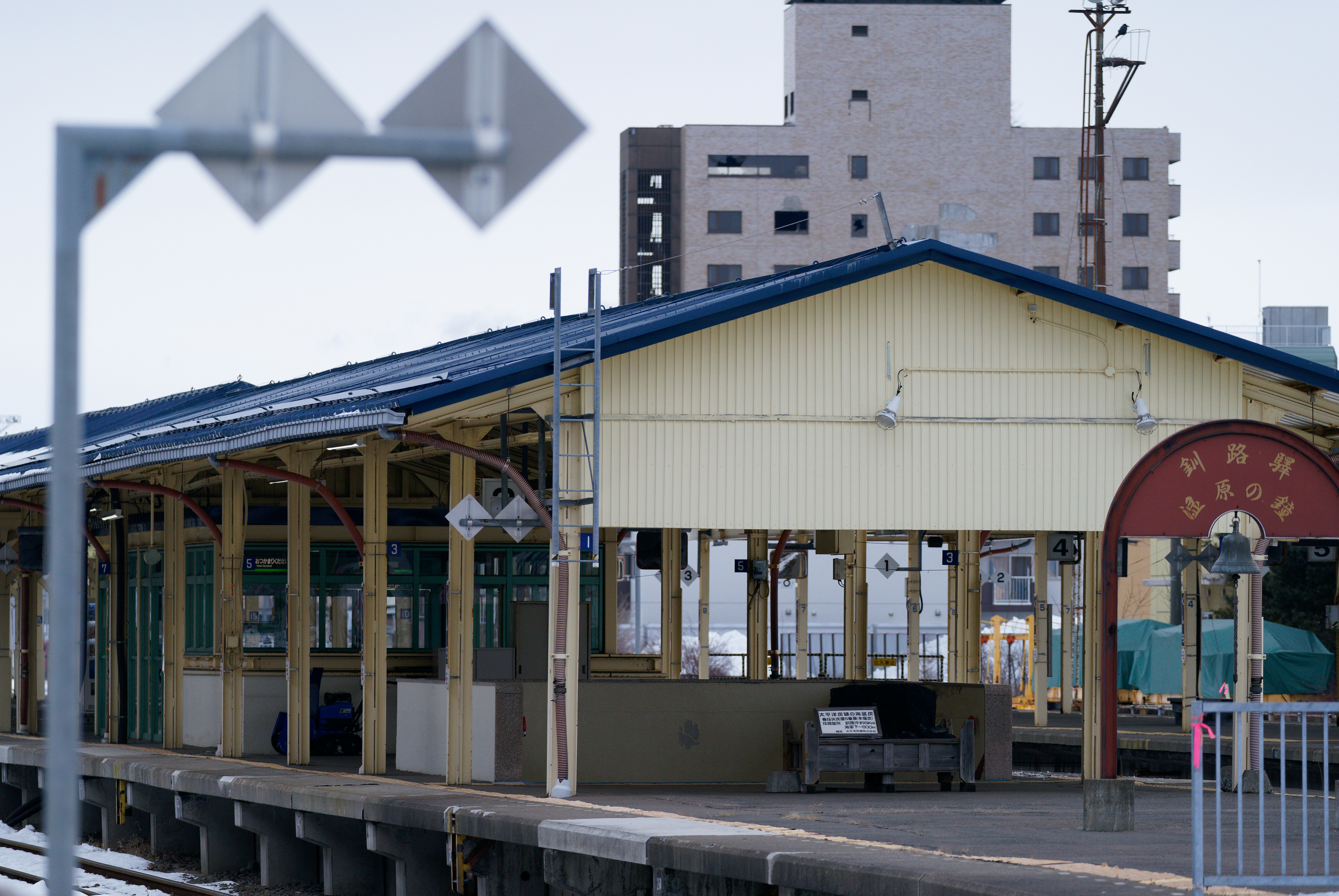 Platform Shadows and Blue-Topped Roof: An Empty Station in Soft Light