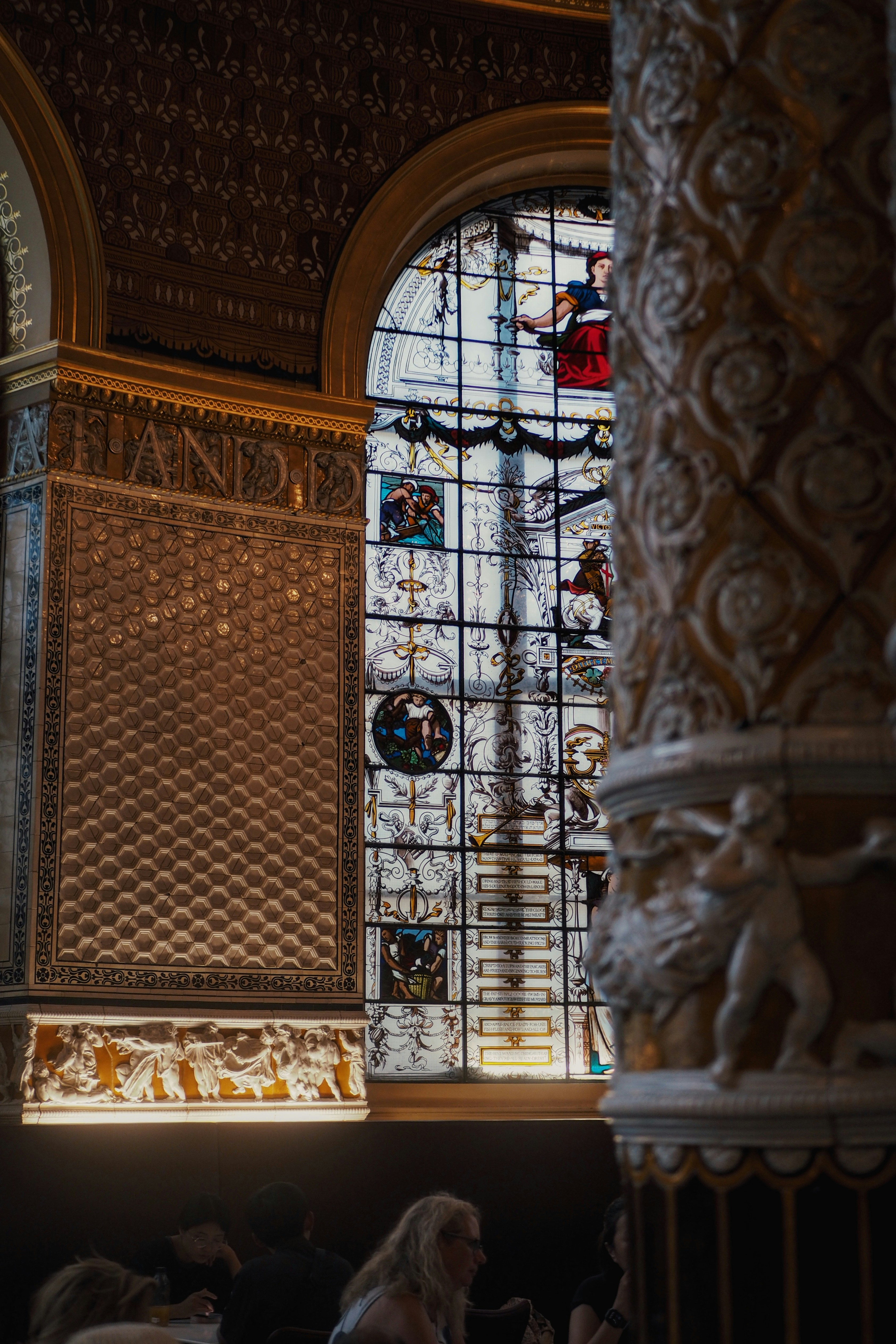 Stained Glass Arches Through Carved Columns