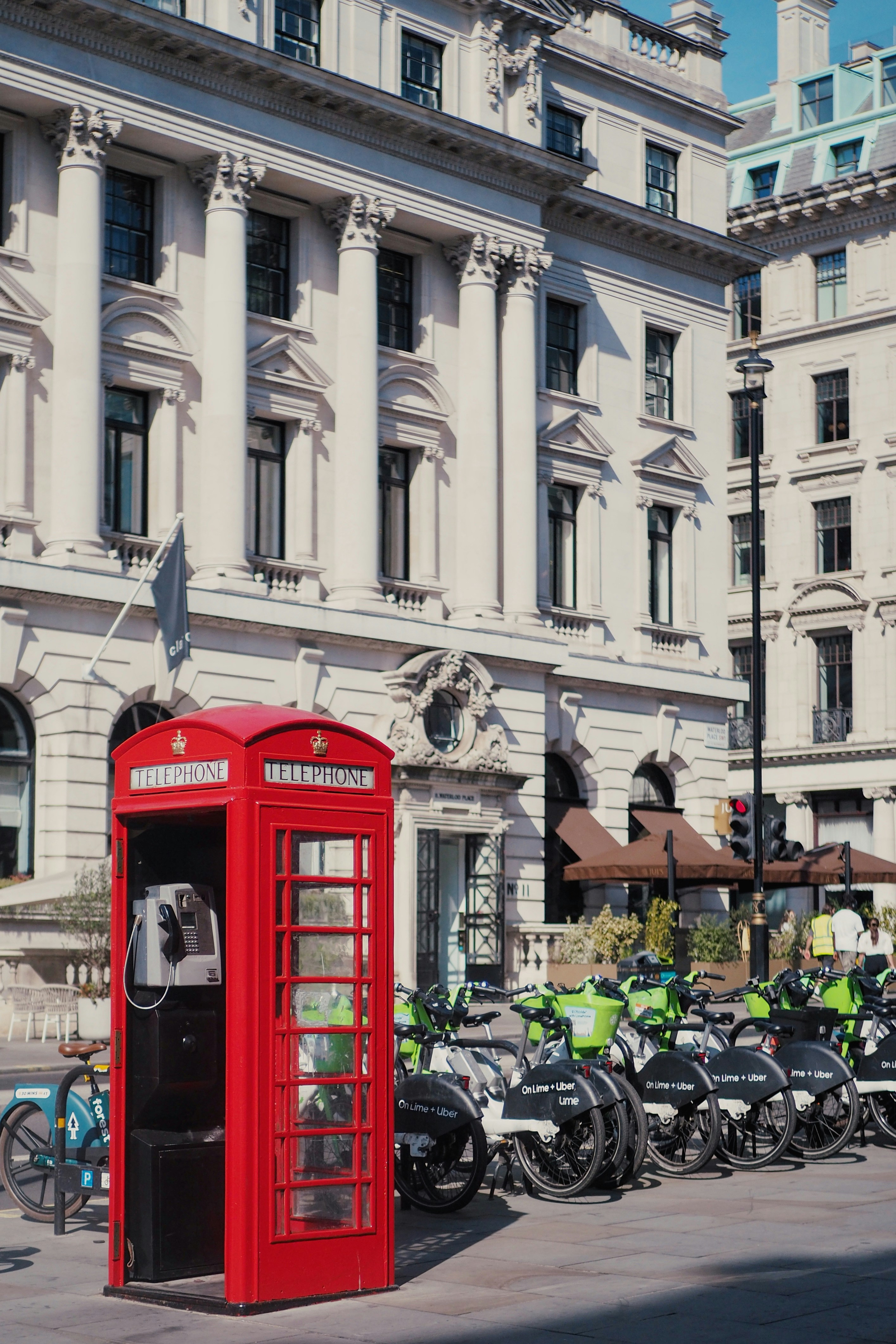 London red in shift: a street-side scene with a classic red phone booth and bicycle rack