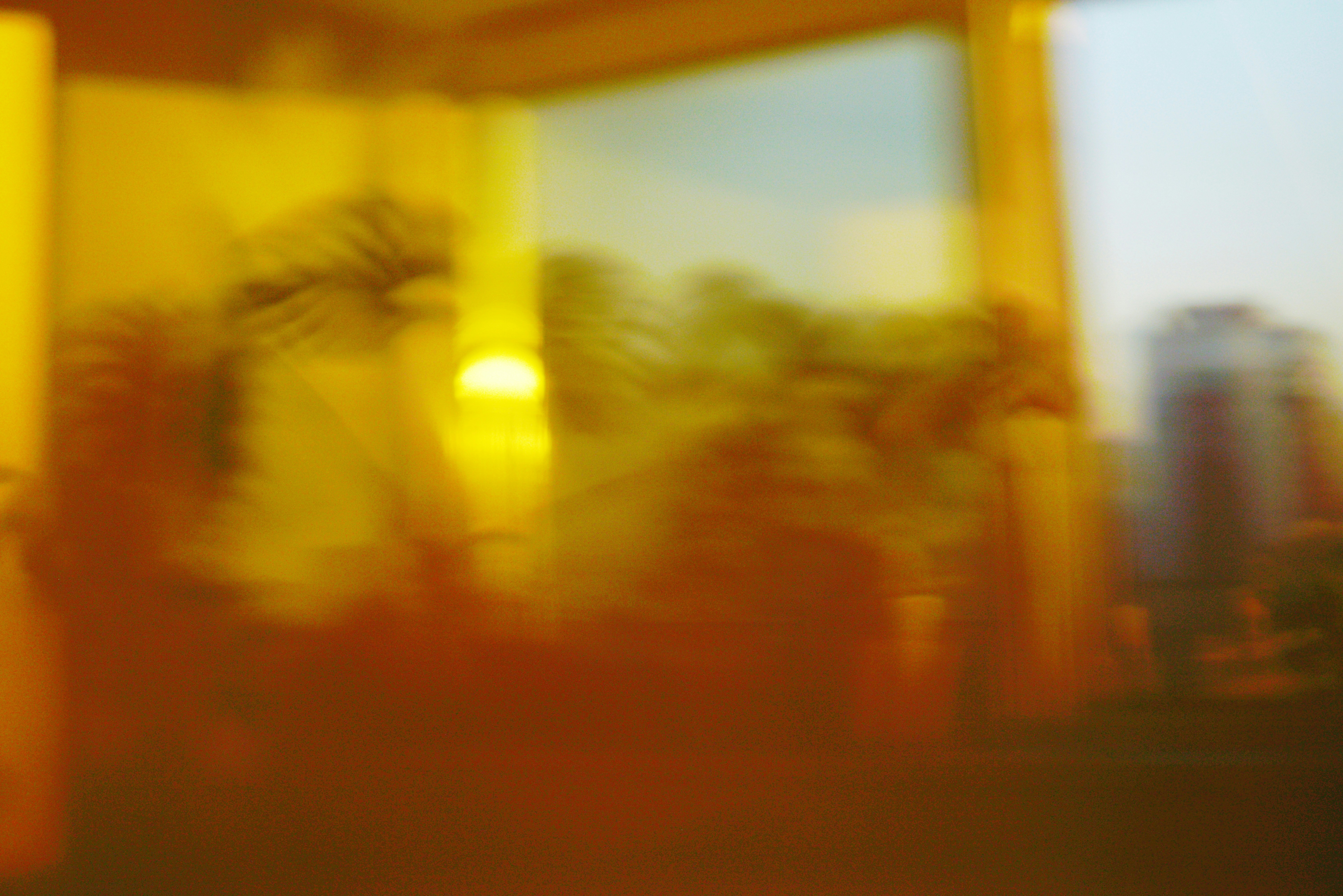 Golden Blur Through Glass: Sunset Reflections in Motion