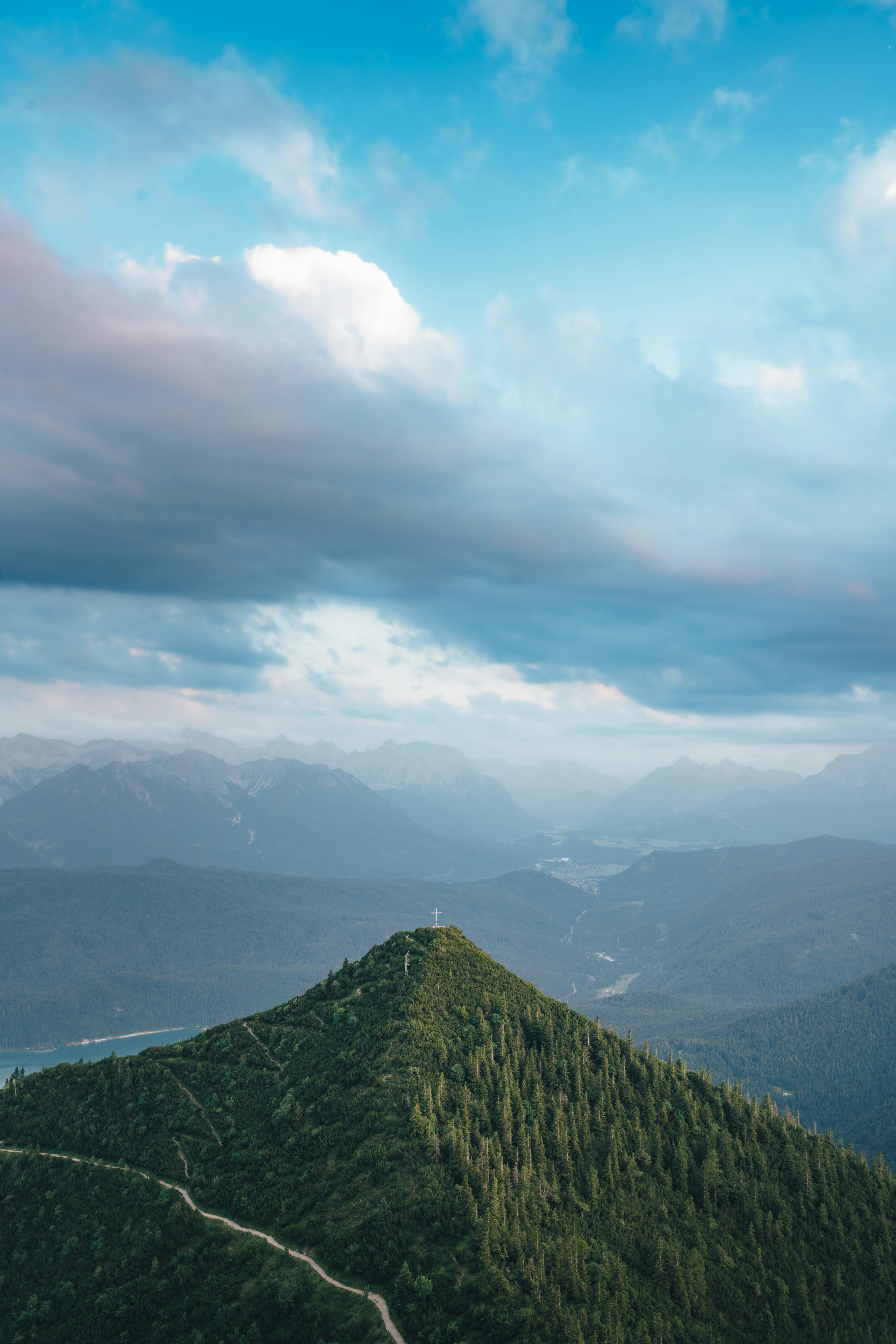 Cross atop the Green Peak: A Quiet Summit under Vast Skies