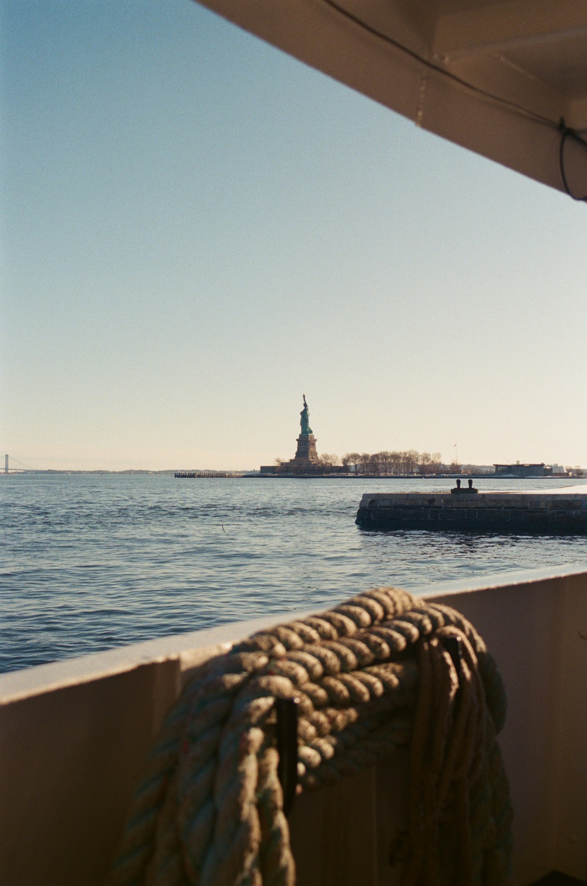 The Statue of Liberty in New York Harbor viewed from a boat deck