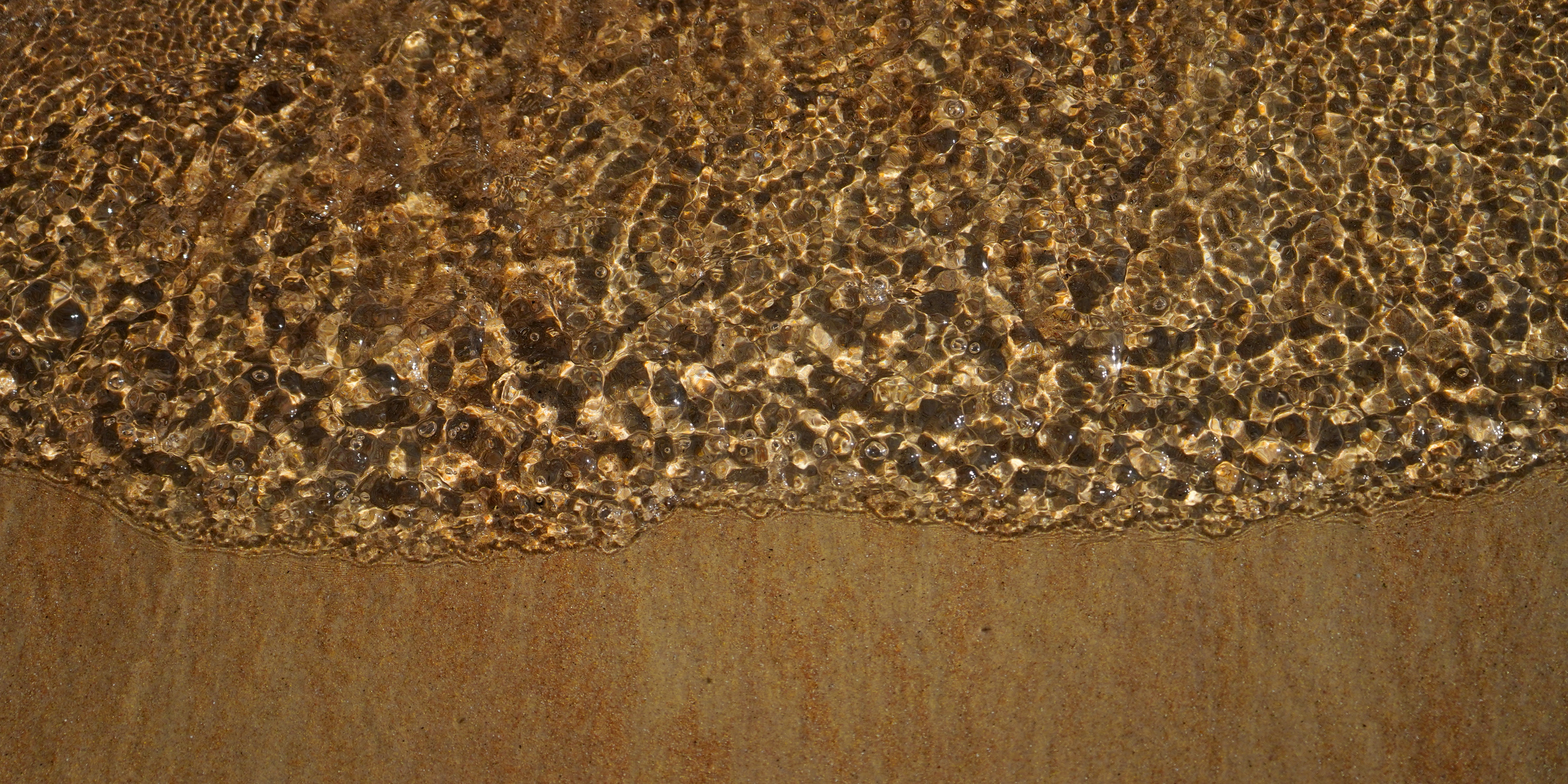 Golden Edge: A Quiet Contact Between Sand and Wavelets