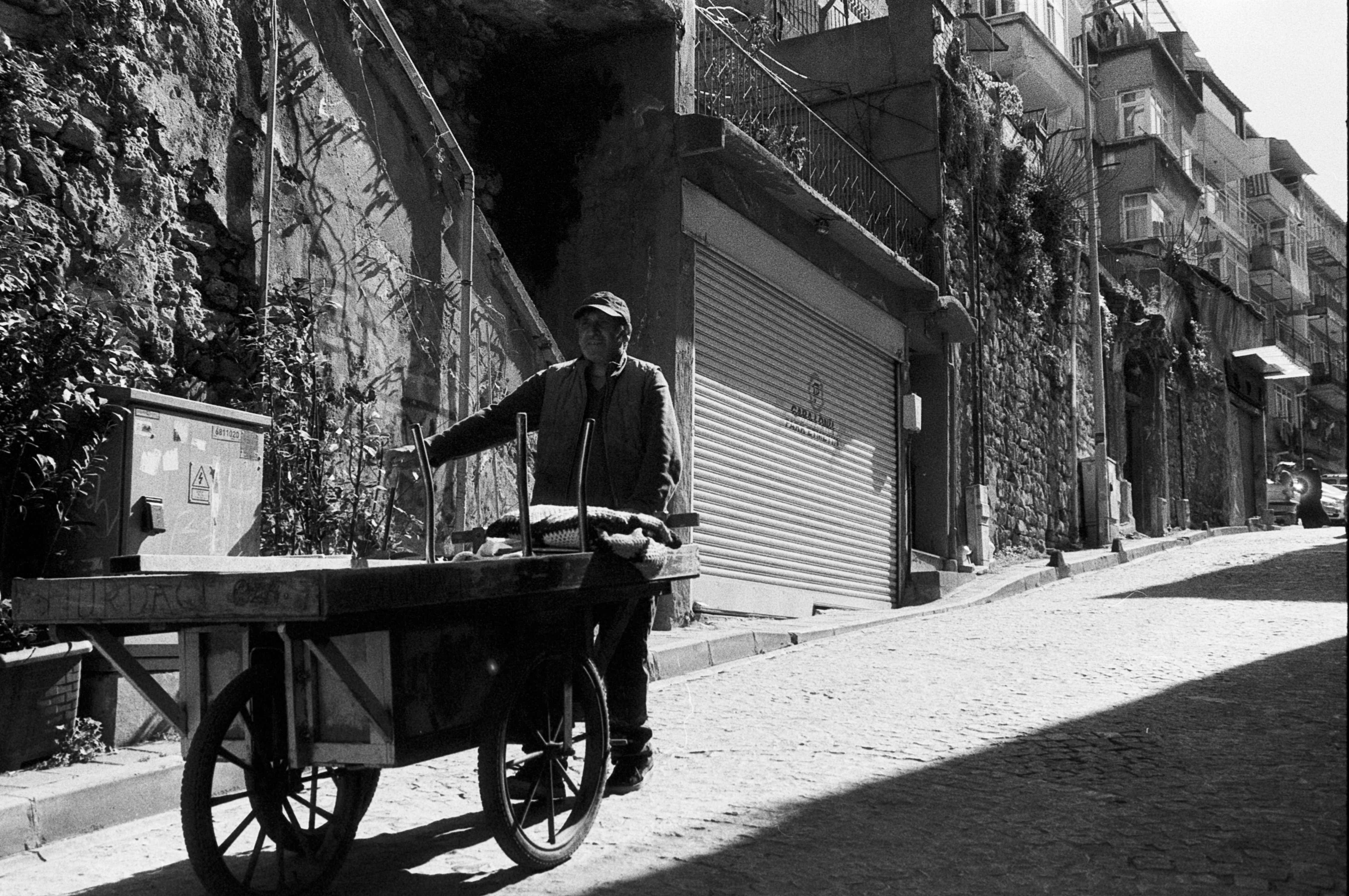 Street Cart at Dusk: A lone vendor on a sunlit incline