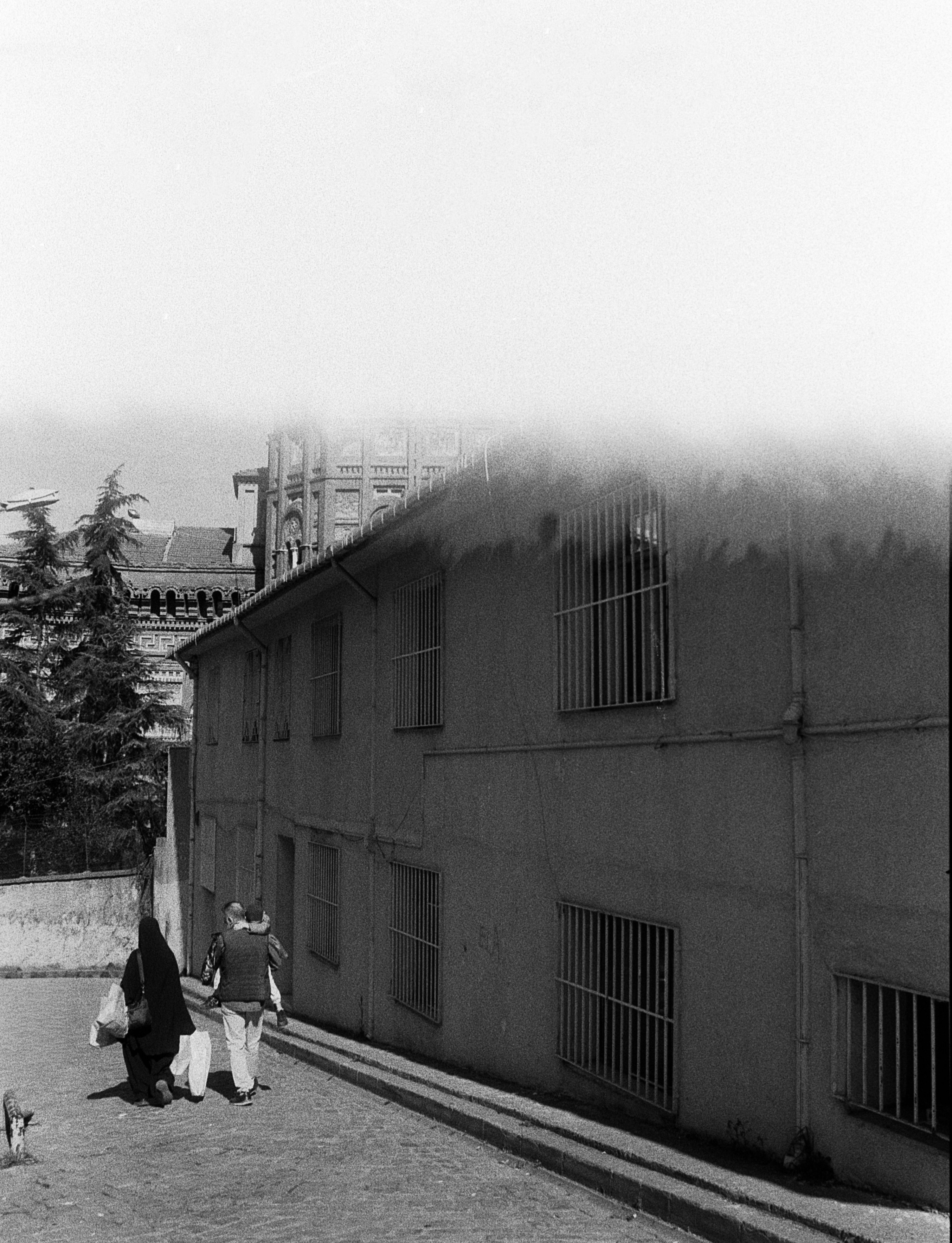Two Shoppers and a Pet on a Narrow Cobbled Street