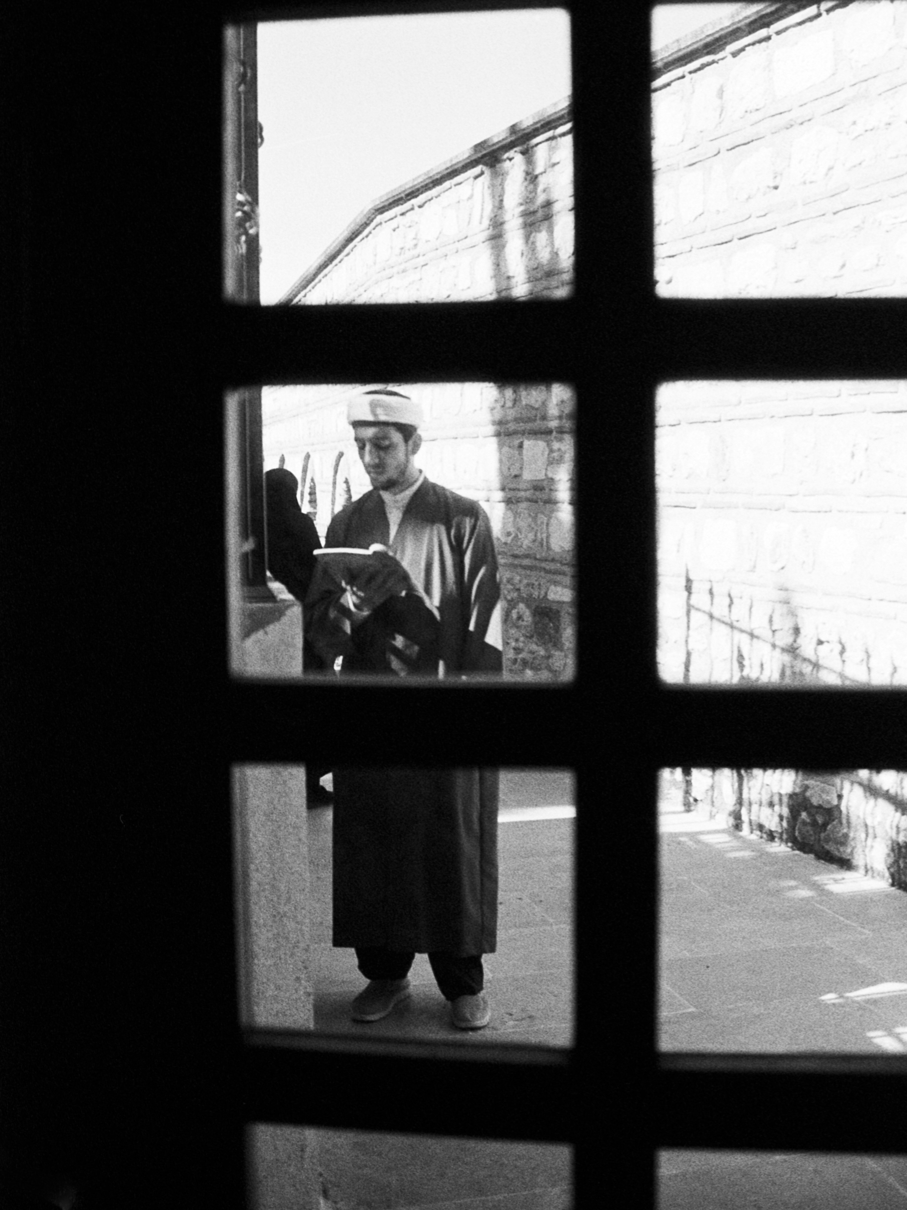 Prison Window Portrait: A Monk Reading Through Grids