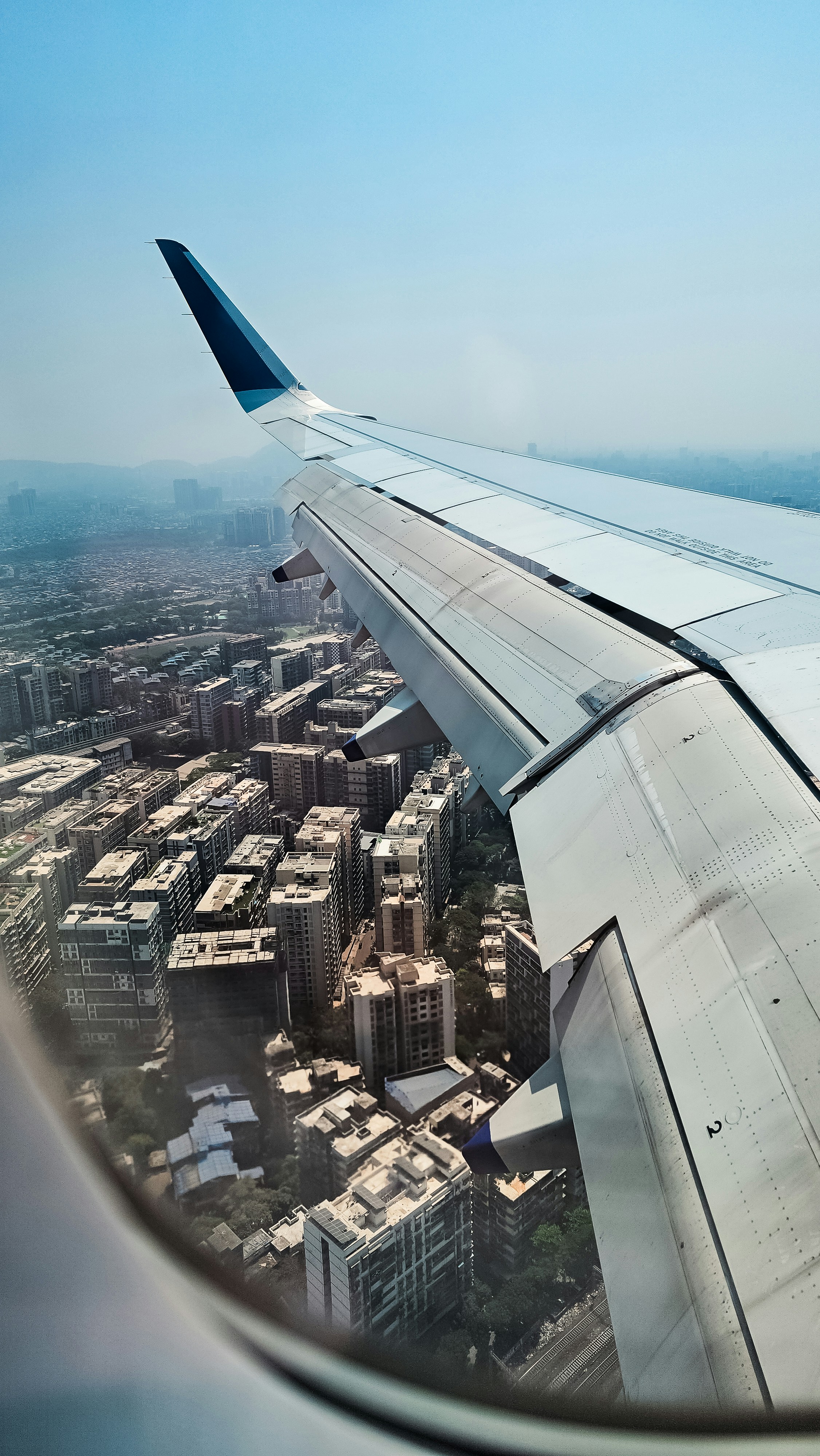  Winged Panorama: cityscape unfurls beneath silver wings