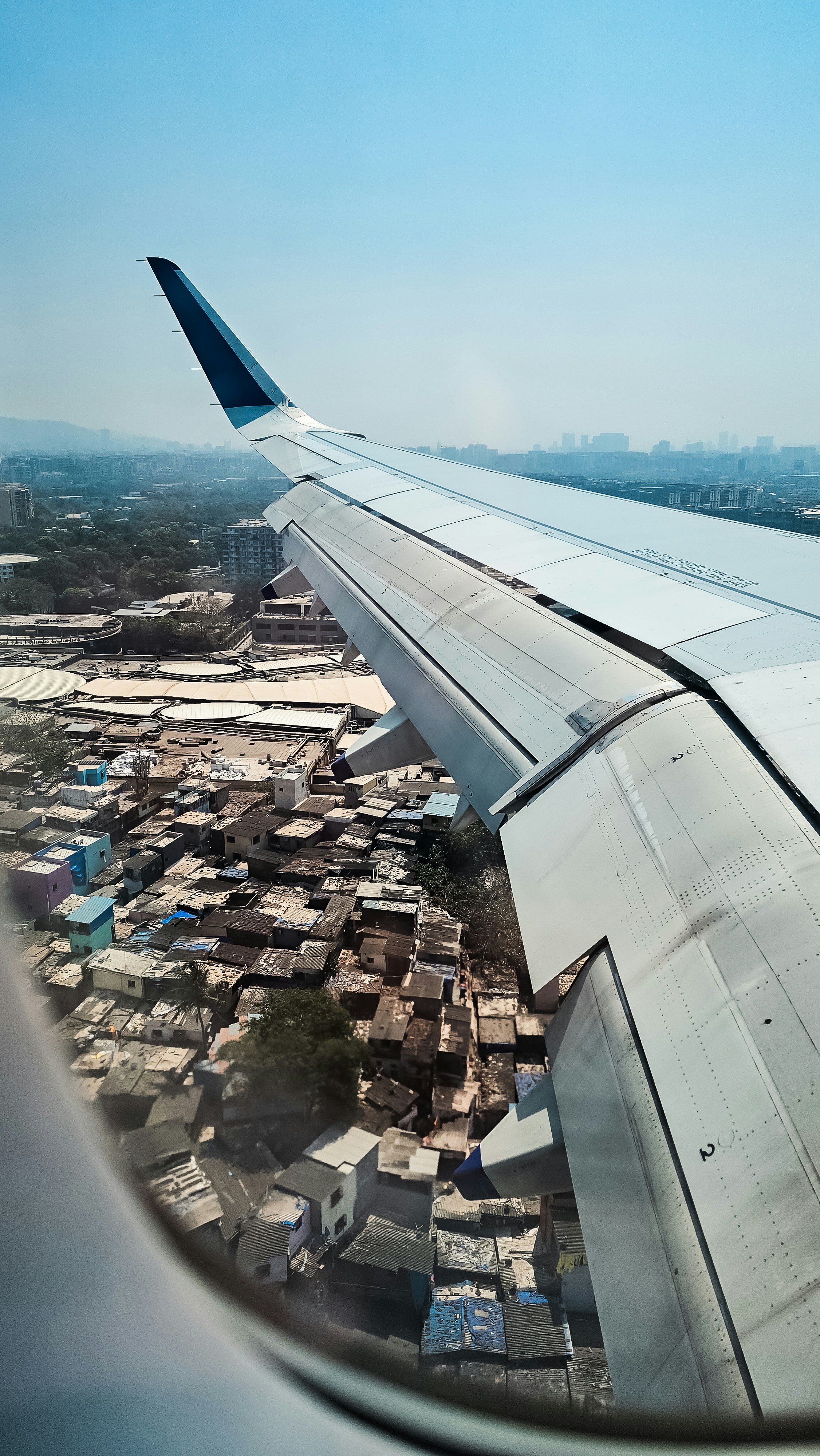Winglit Over City: A Window into Flight and Urban Tapestry