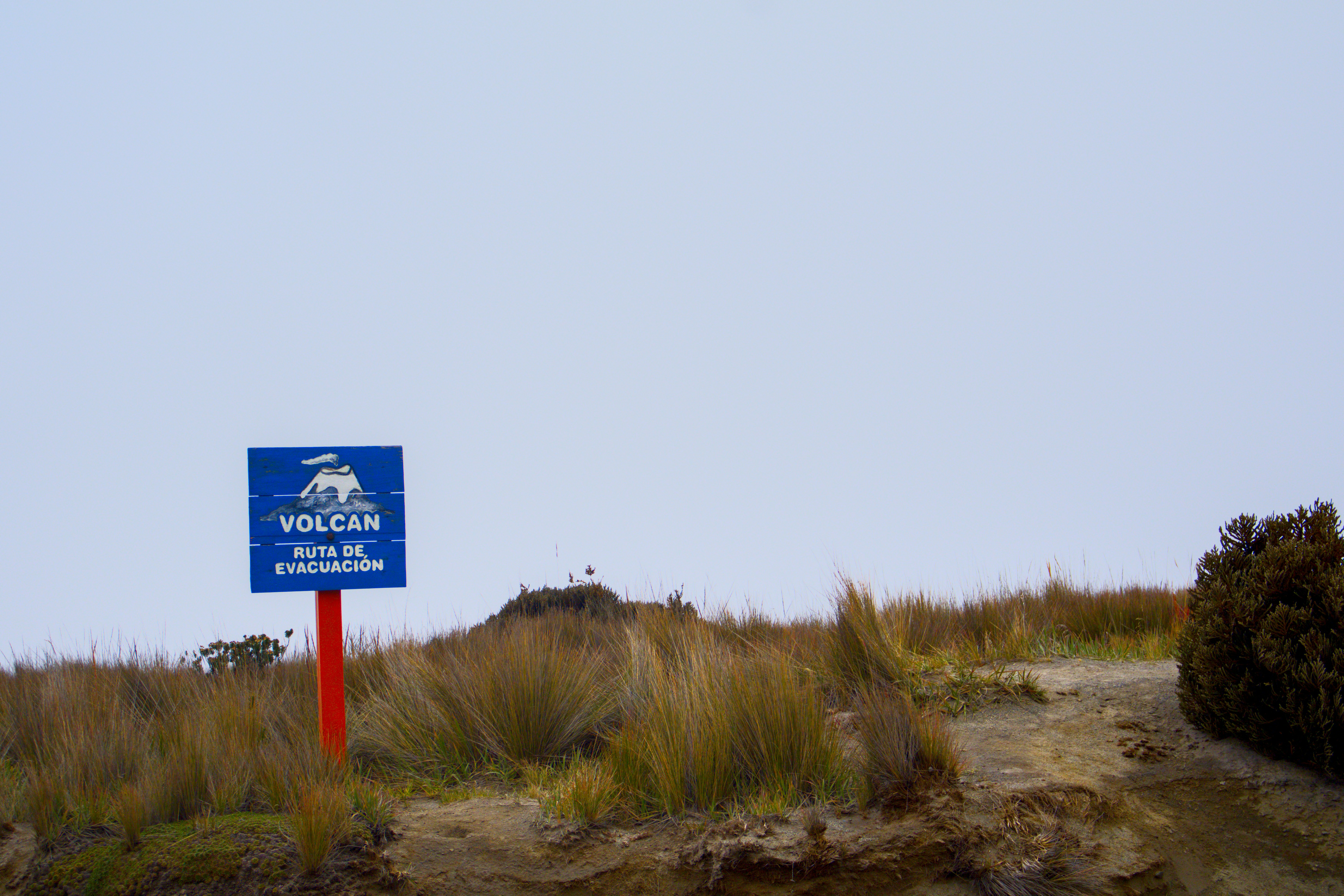 Blue Warning Sign at Desert Pathway