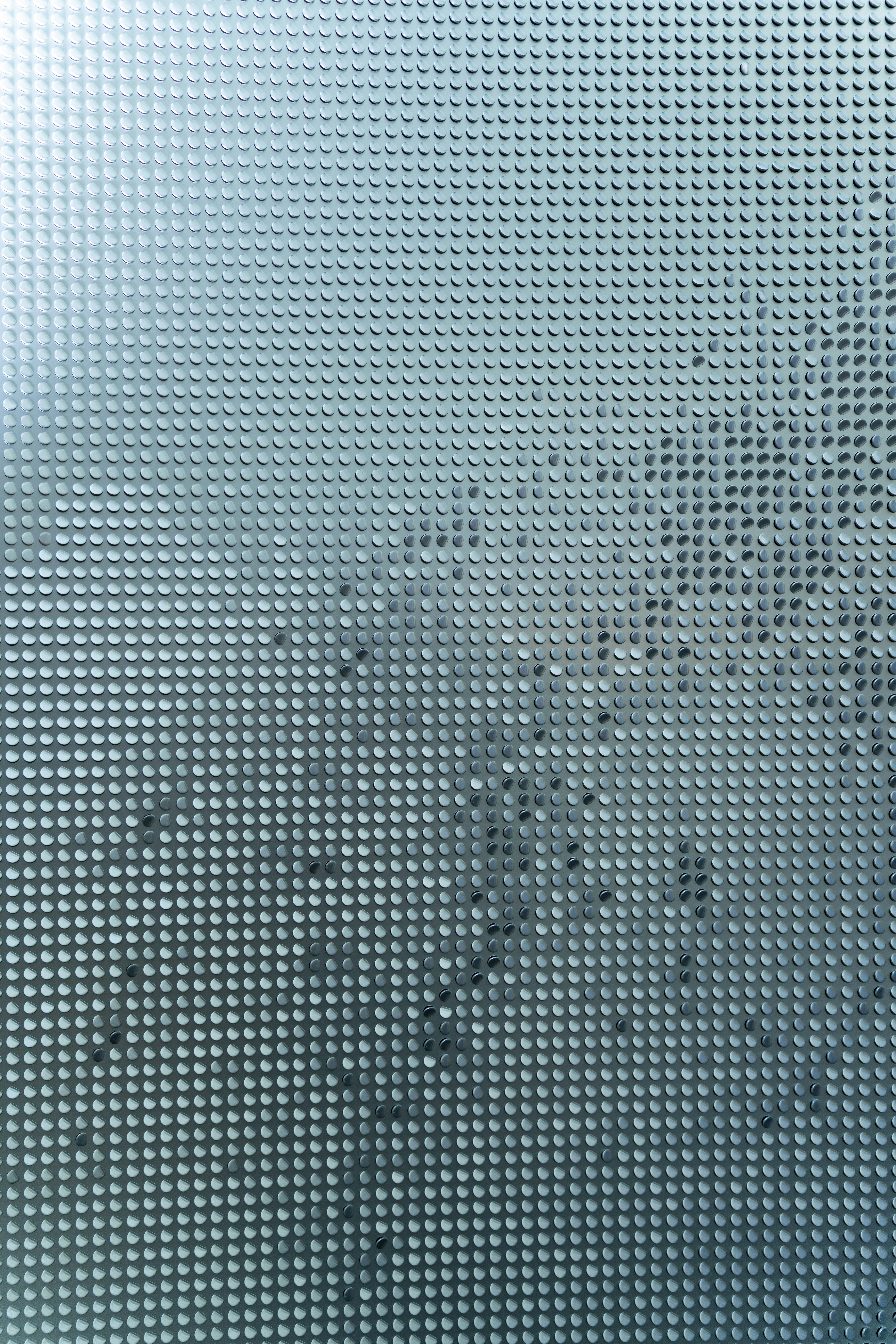 Fogged Glass Rhythm: A Dotted Facade Behind Frosted Texture