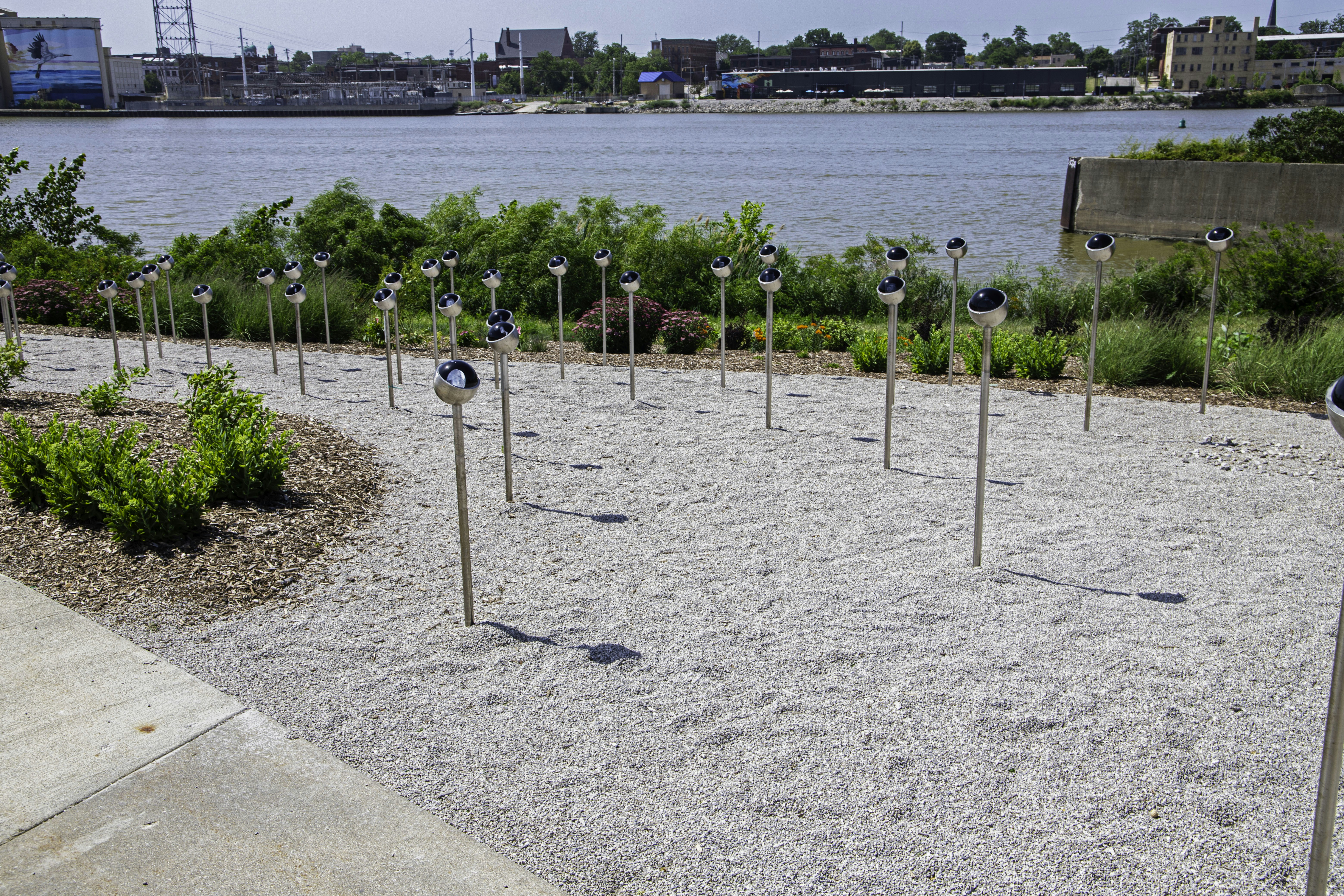 Mirror Garden by the Waterfront: Stainless Poles Reflecting the Sky