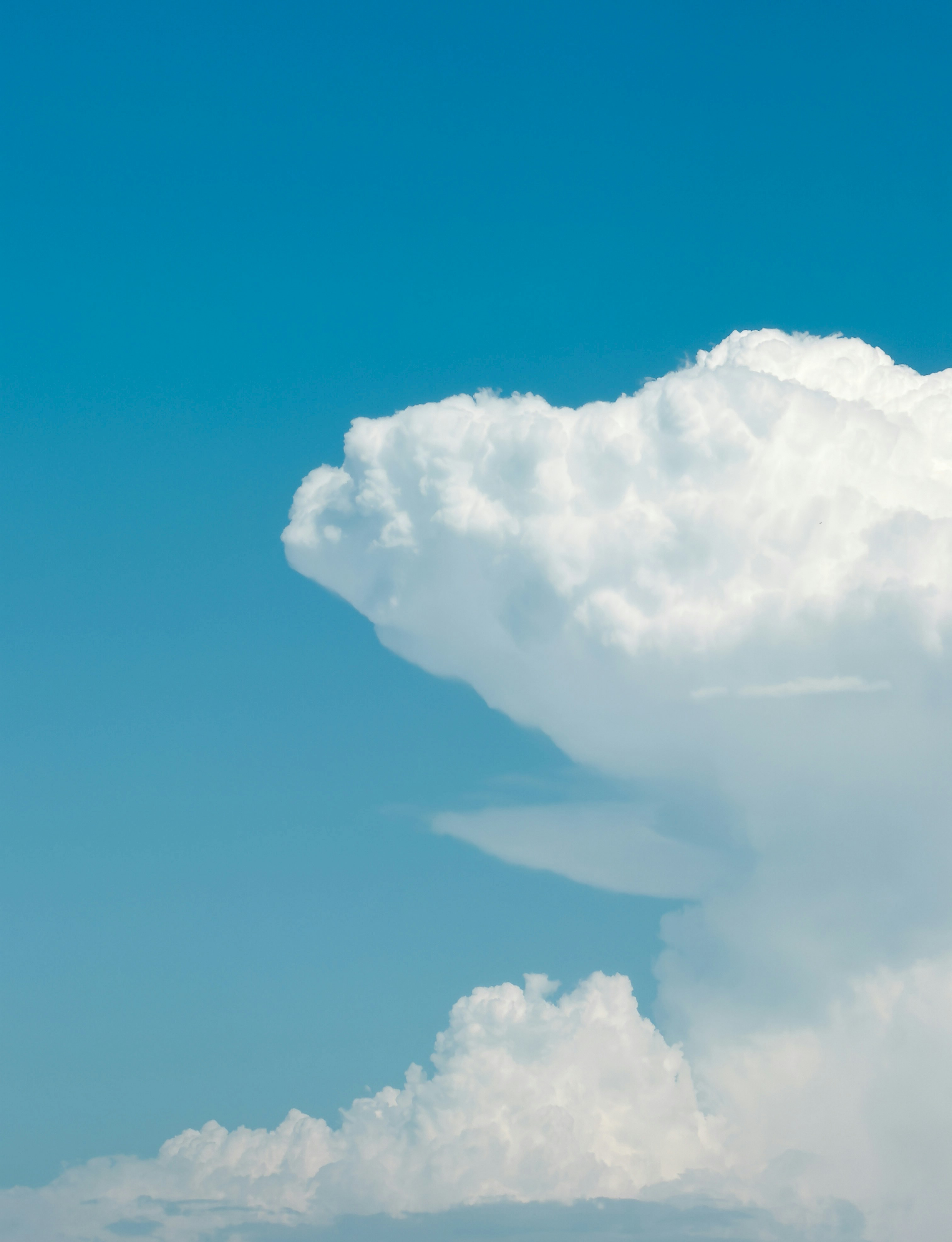 Azure Summit: A Pillar of Cloud Against a Clear Sky