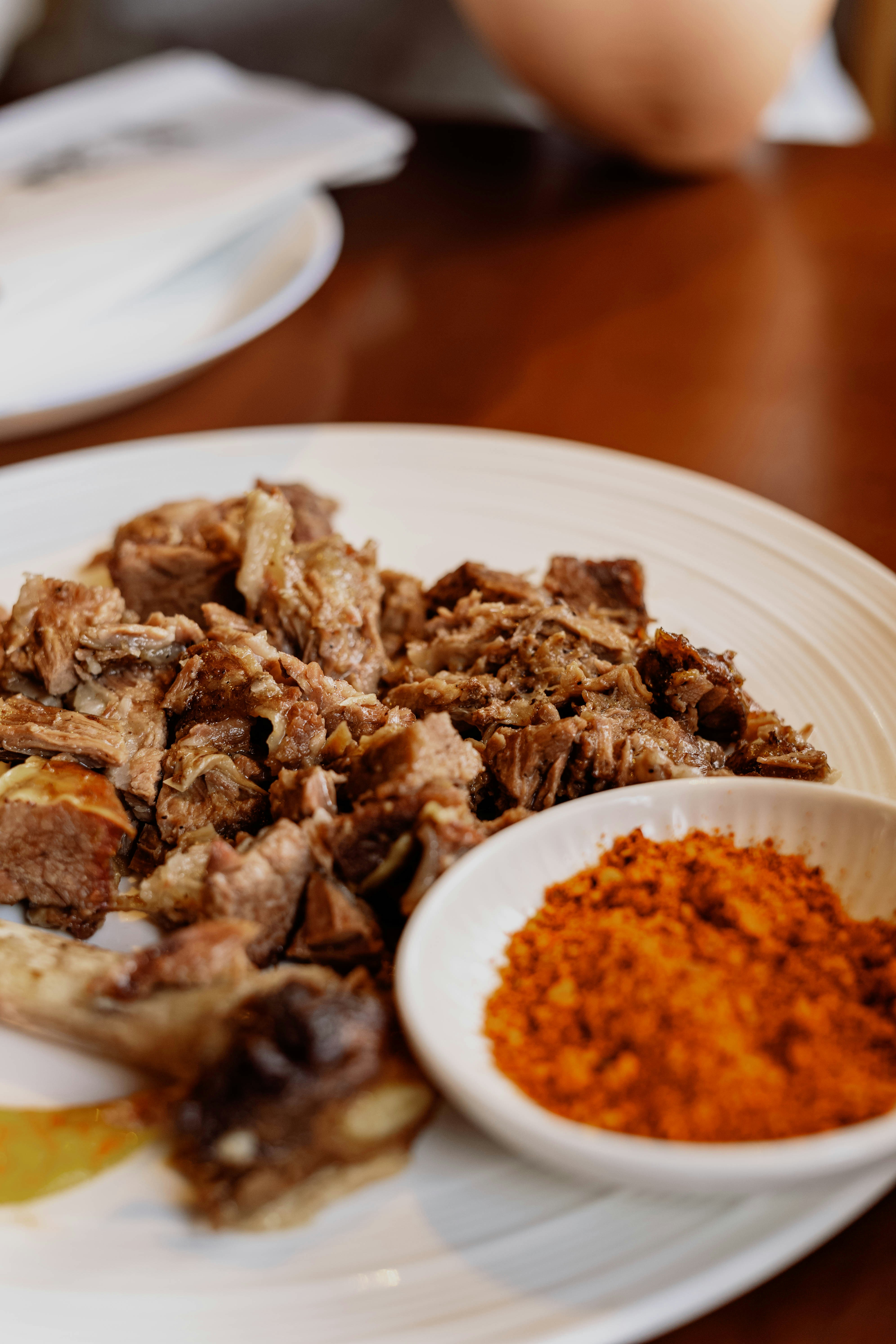 Rugged plate of braised meat with a spicy side