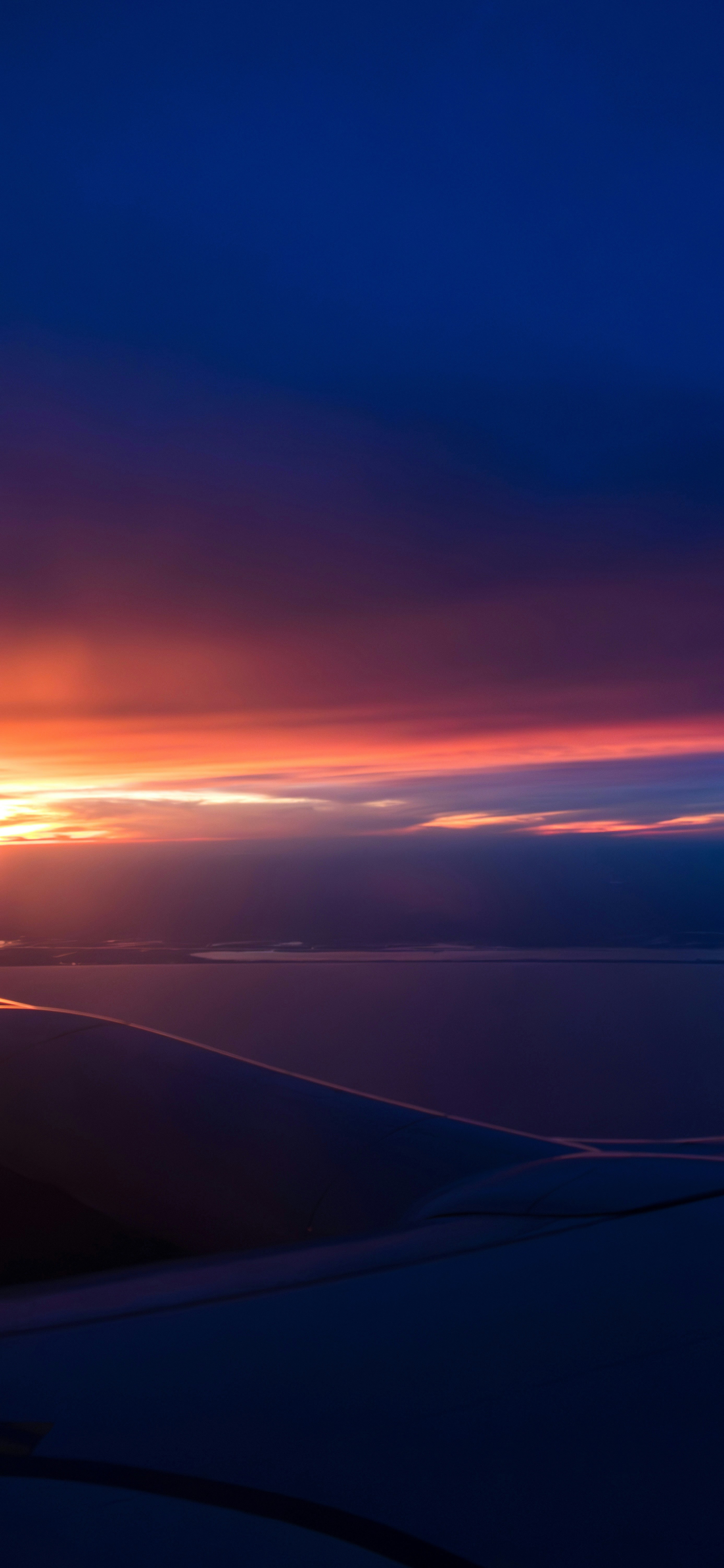 Sunset Arc over the Wing: Quiet Horizon from the Window