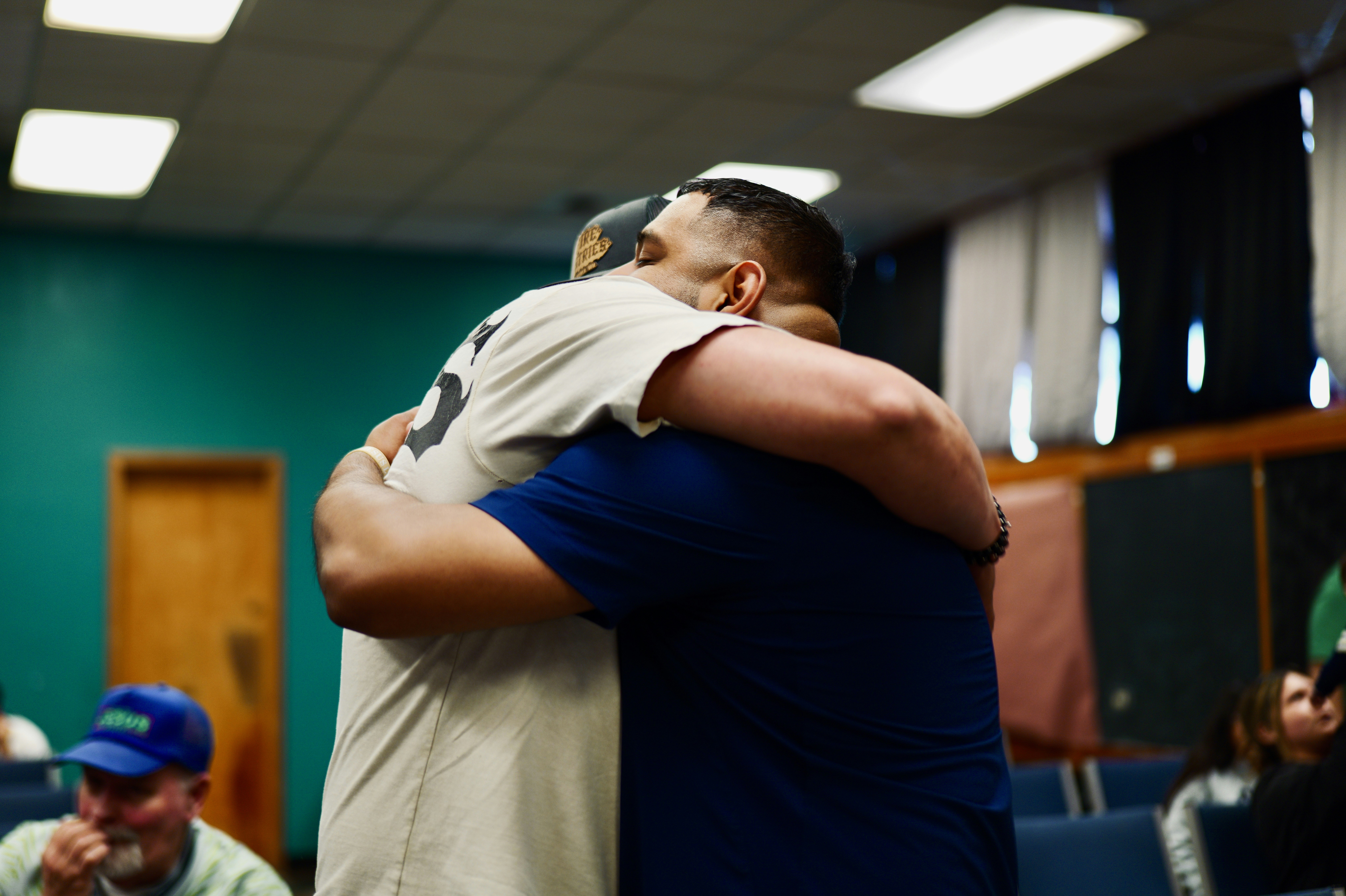 Hug Across the Room: A Warm Embrace in a Quiet Moment