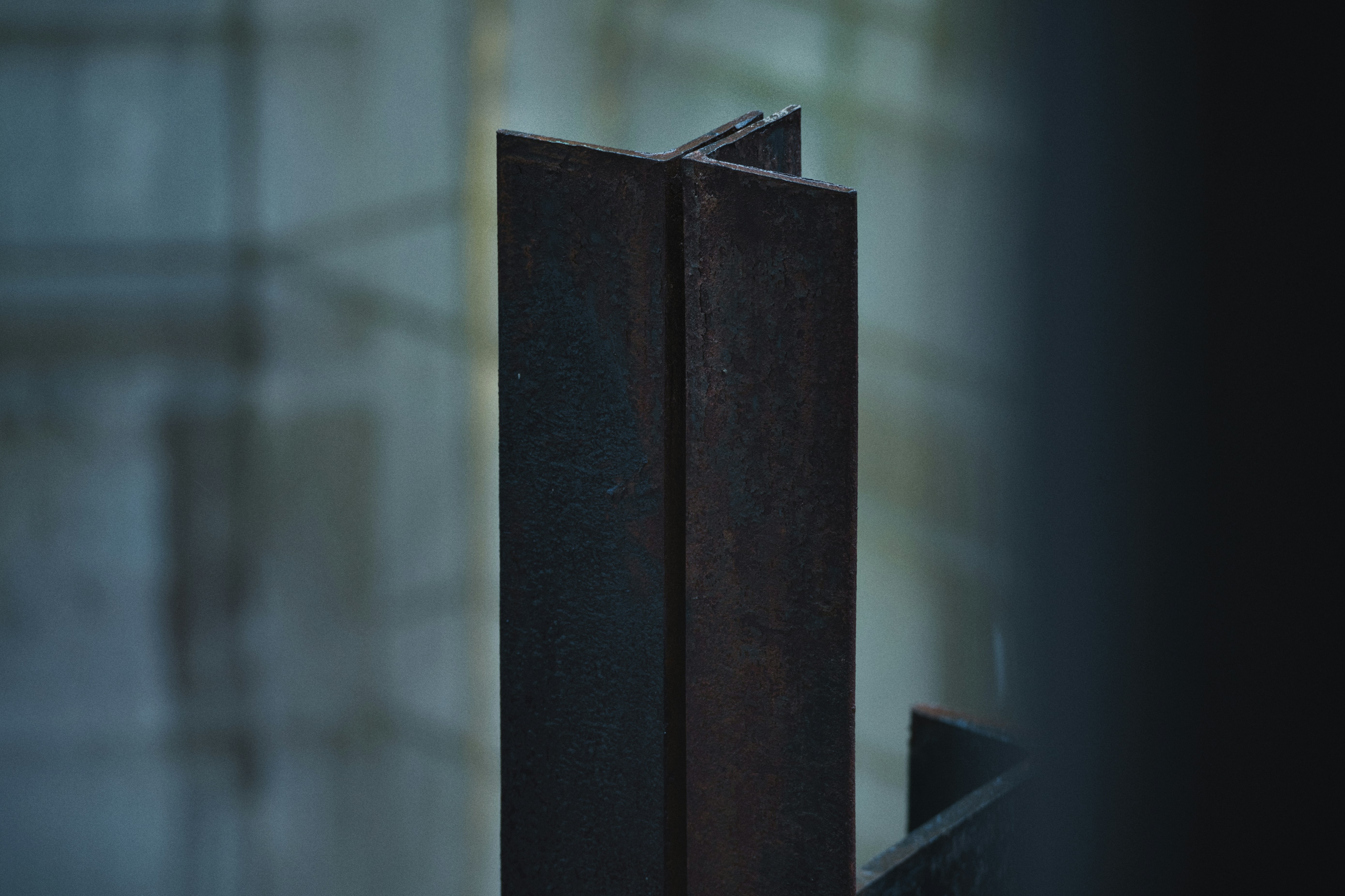 Rusting Geometry: A Close-Up of Steel Beams in Soft Industrial Light
