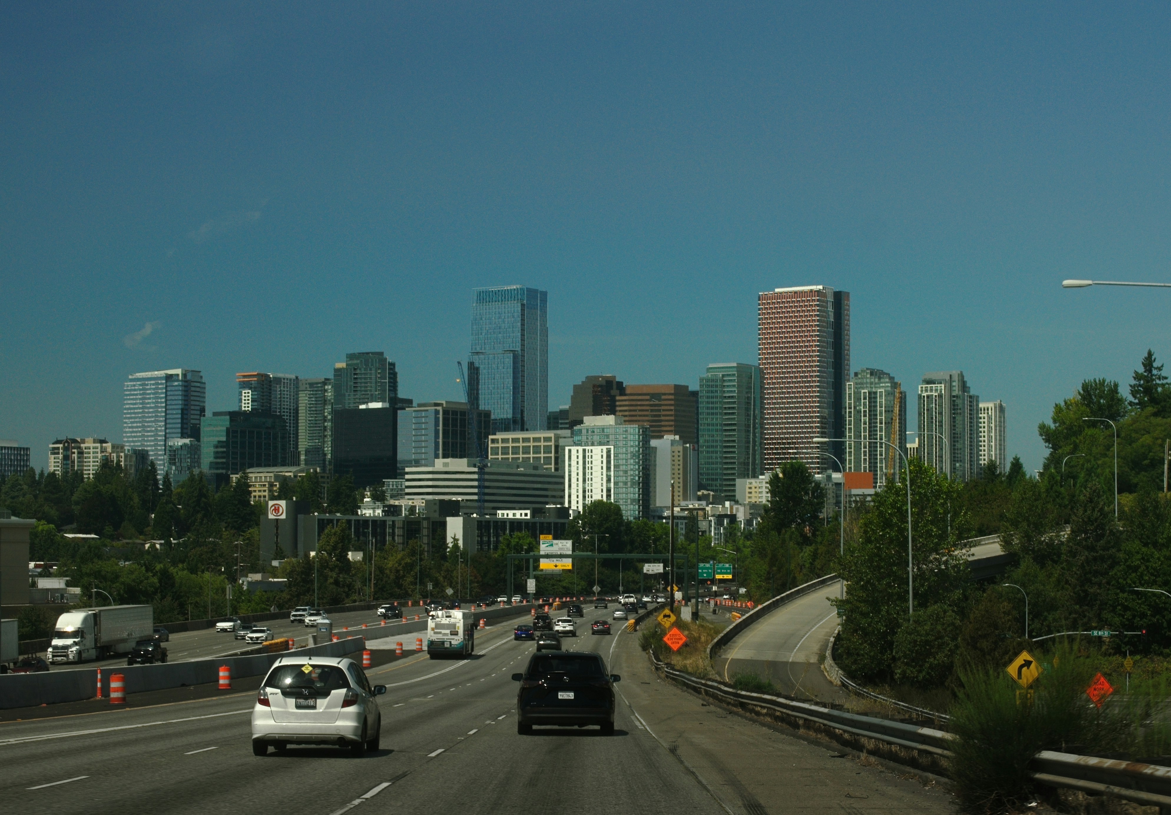 Cityscape on the Move: Highway Lines Toward a Glassy Skyline