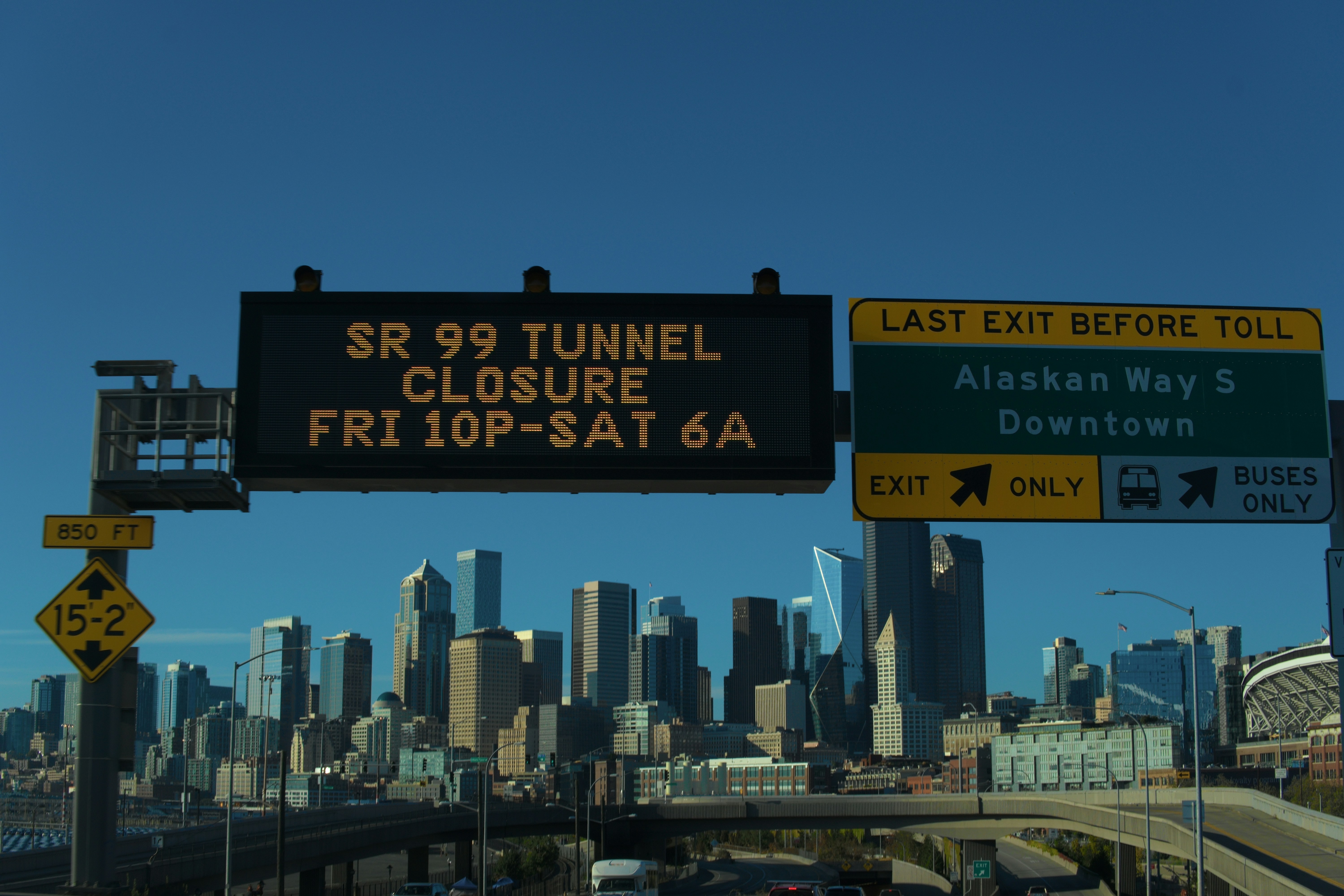 Highway Sign Odyssey Over Downtown Skyline