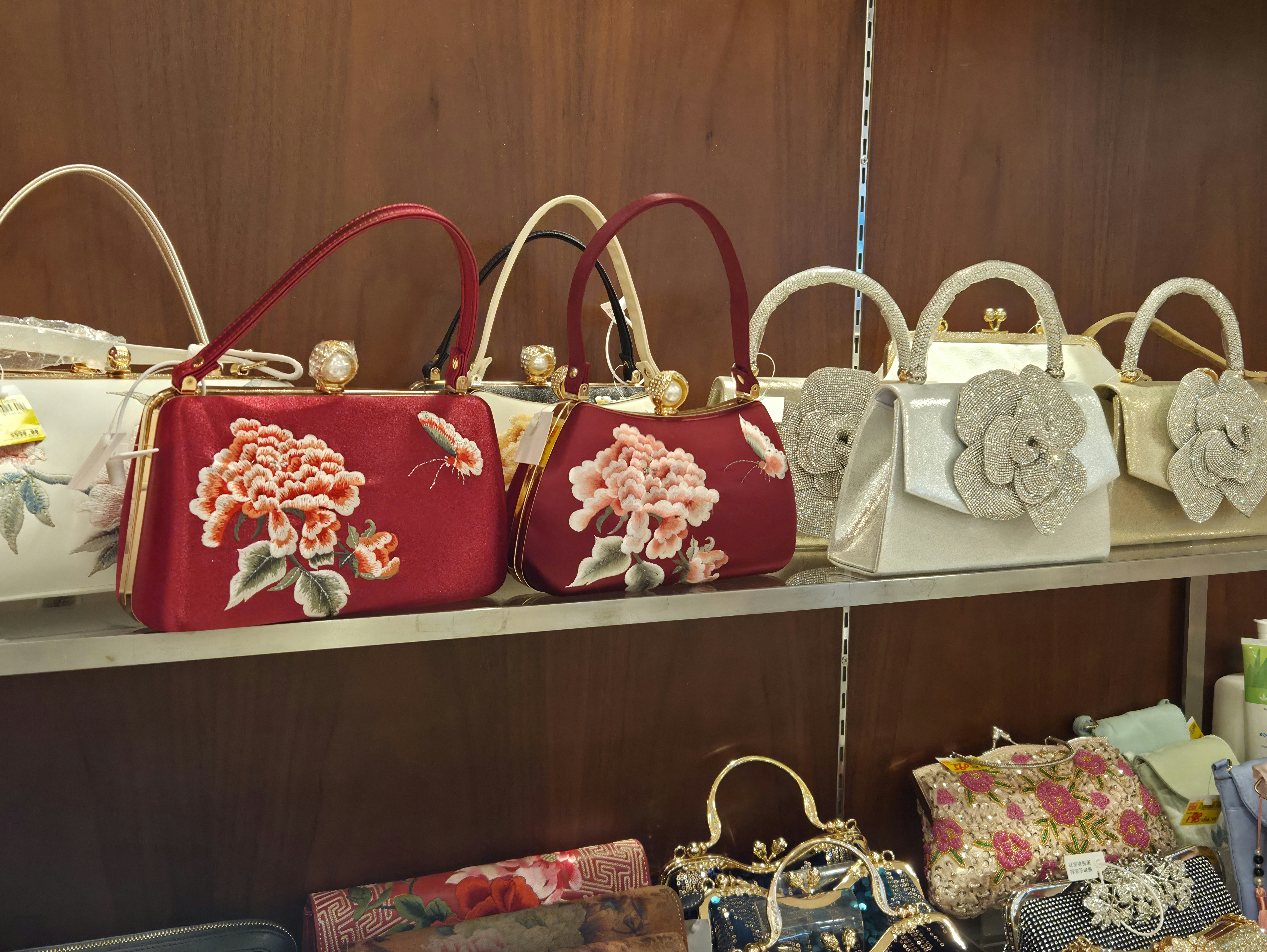 Embroidered Elegance: Row of Floral Evening Bags on a Wooden Shelf