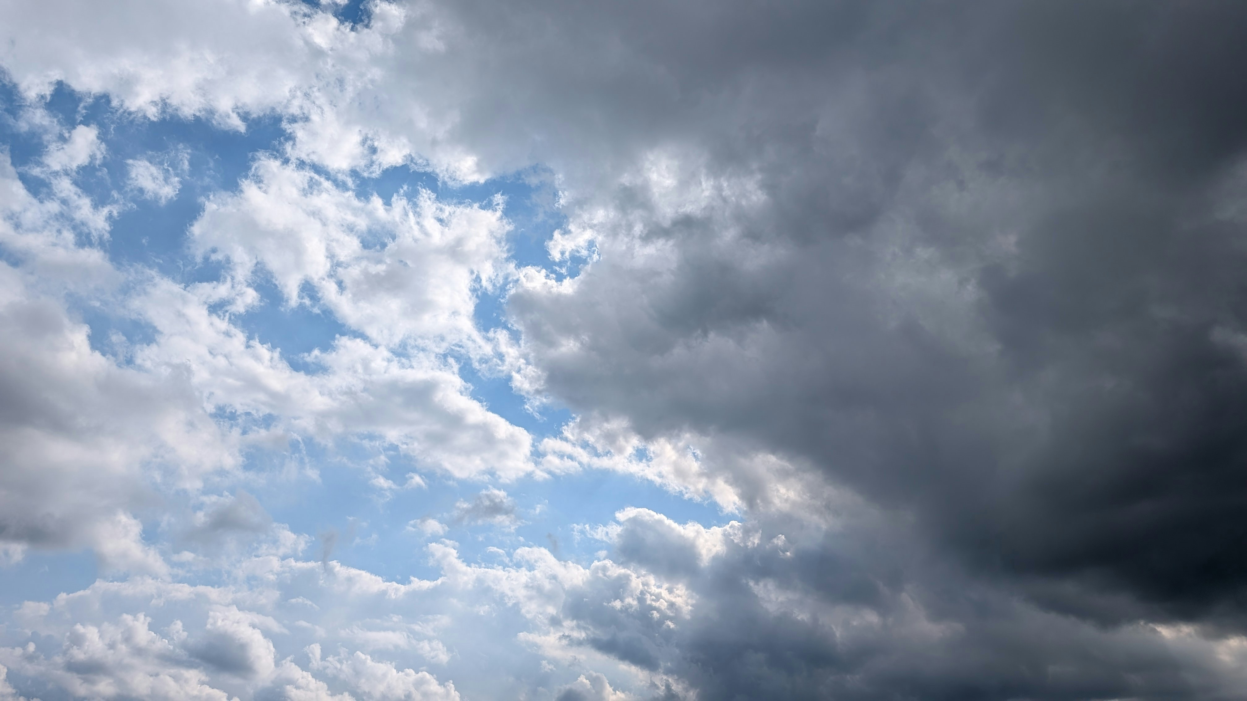 Contrasting Skies: Light Breaks Through a Stormy Veil