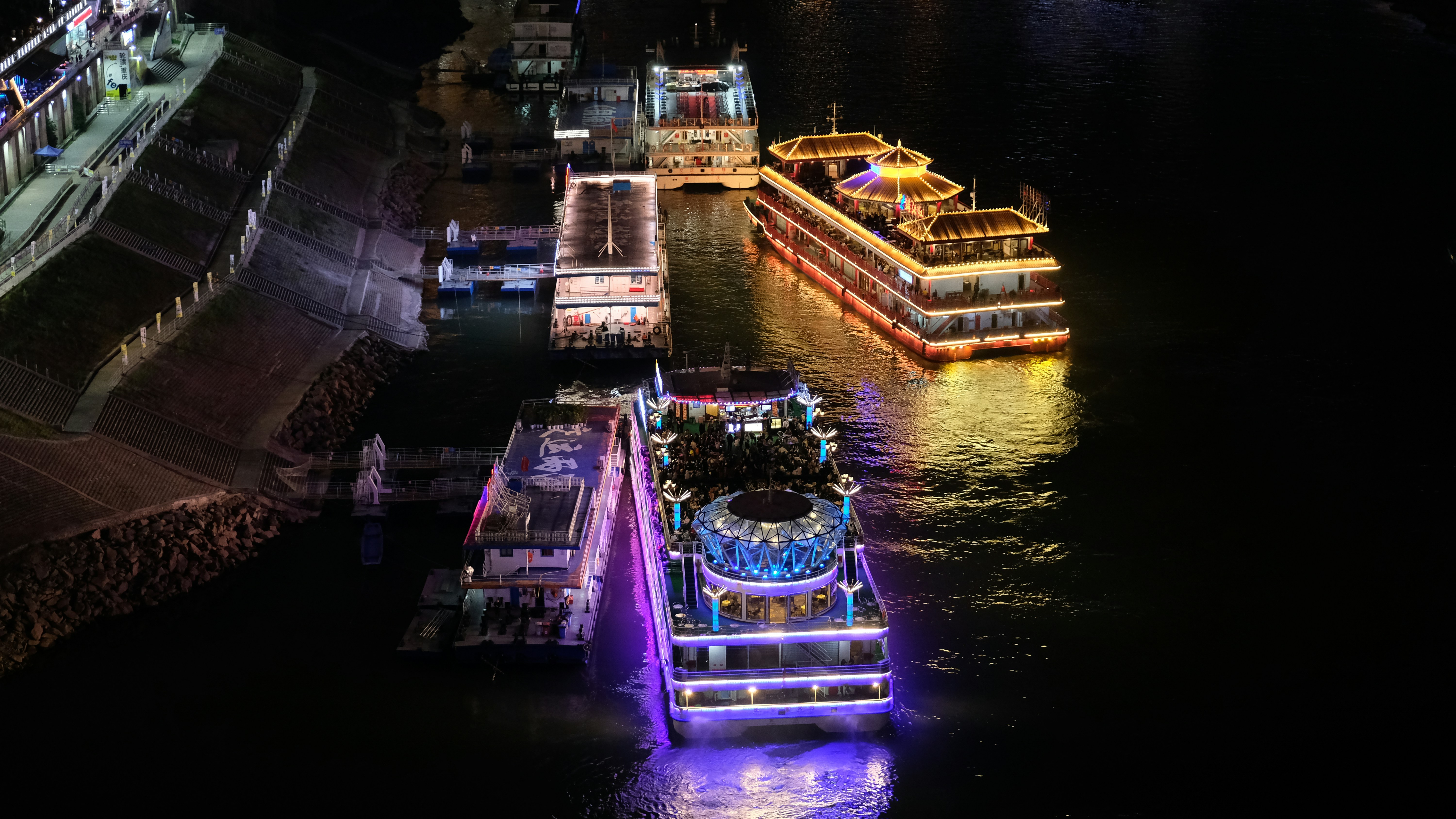 Nighttime Parade: Neon-Tinted Boats Drift Along a Quiet River