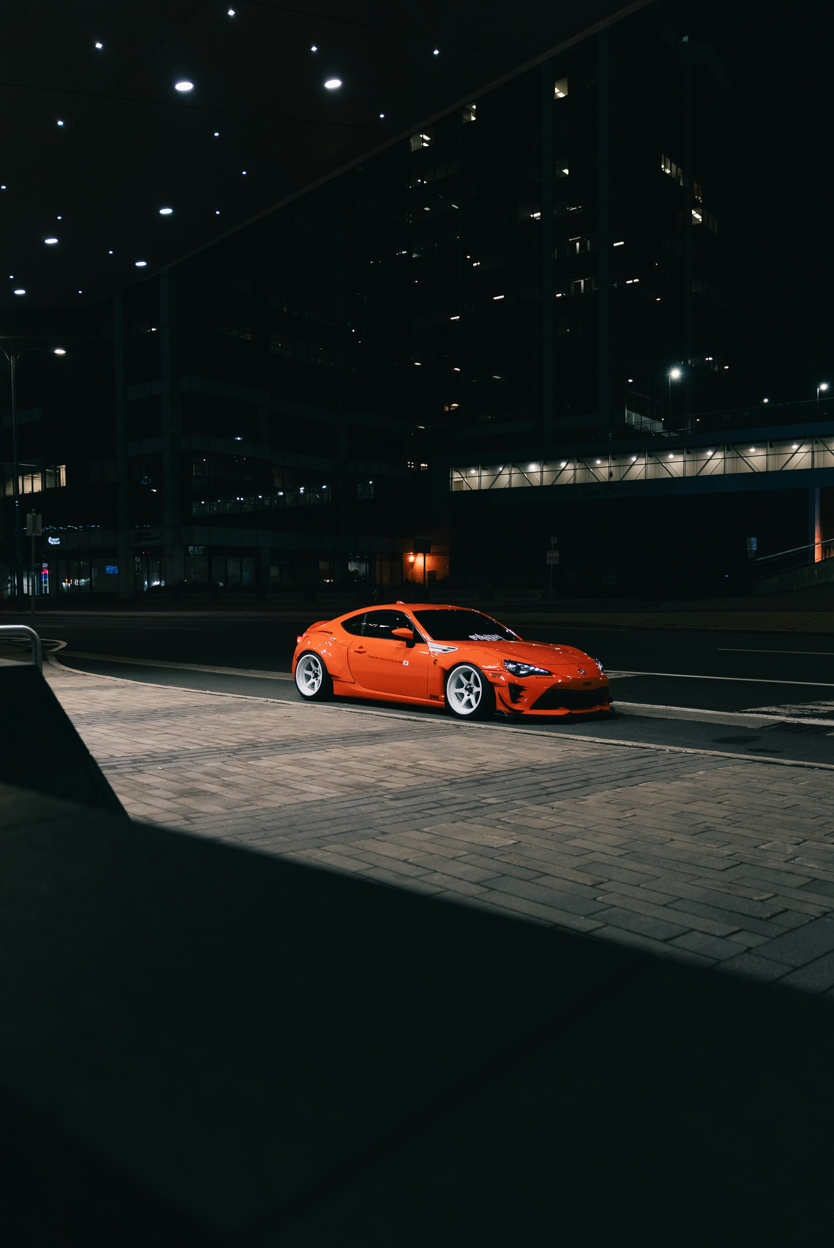 Red Coupe in Neon Quiet: Nighttime Urban Car Portrait