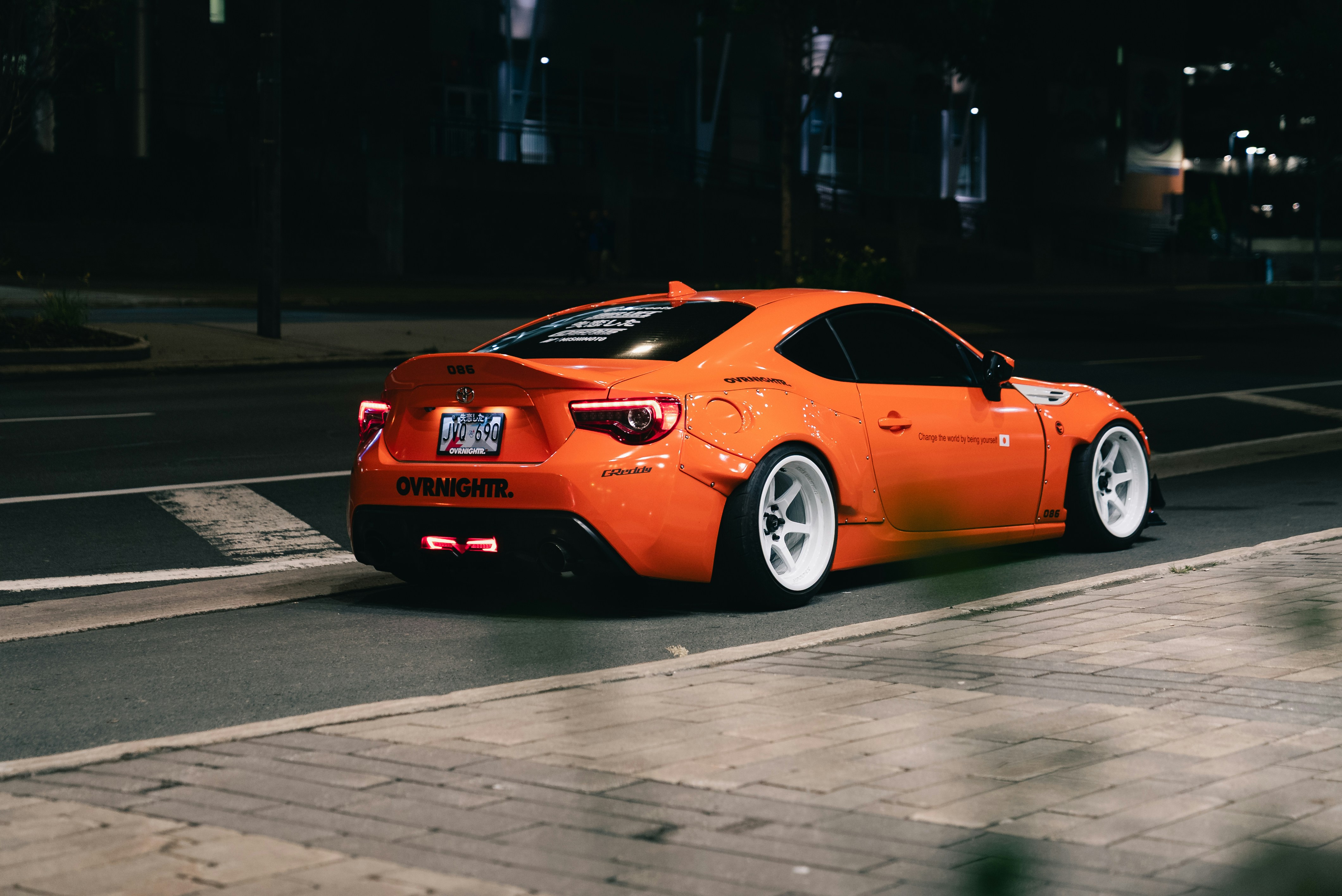 Orange Thunder: Night Street Car Under Neon Lights