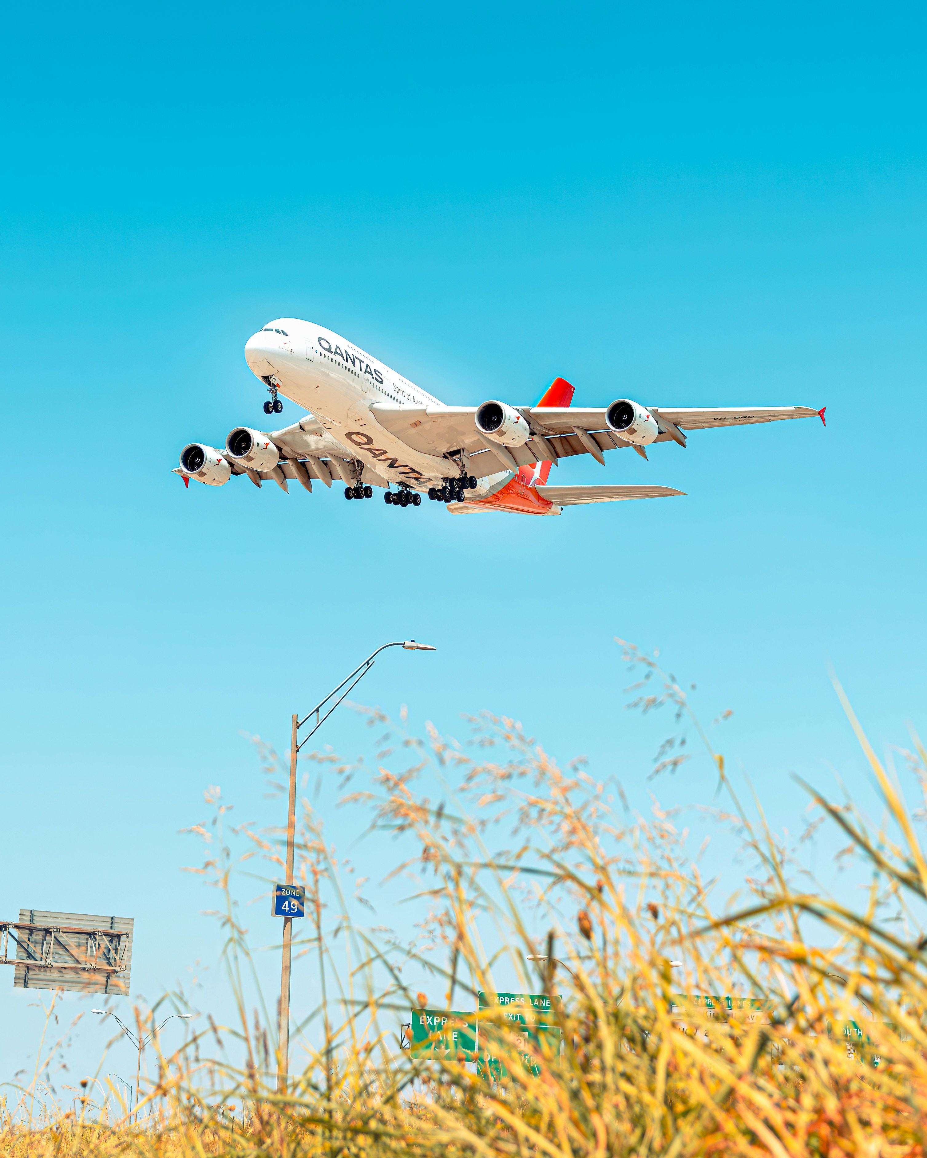 Underwing in the Blue: Qantas A380 Skimming Above a Sunrise Highway
