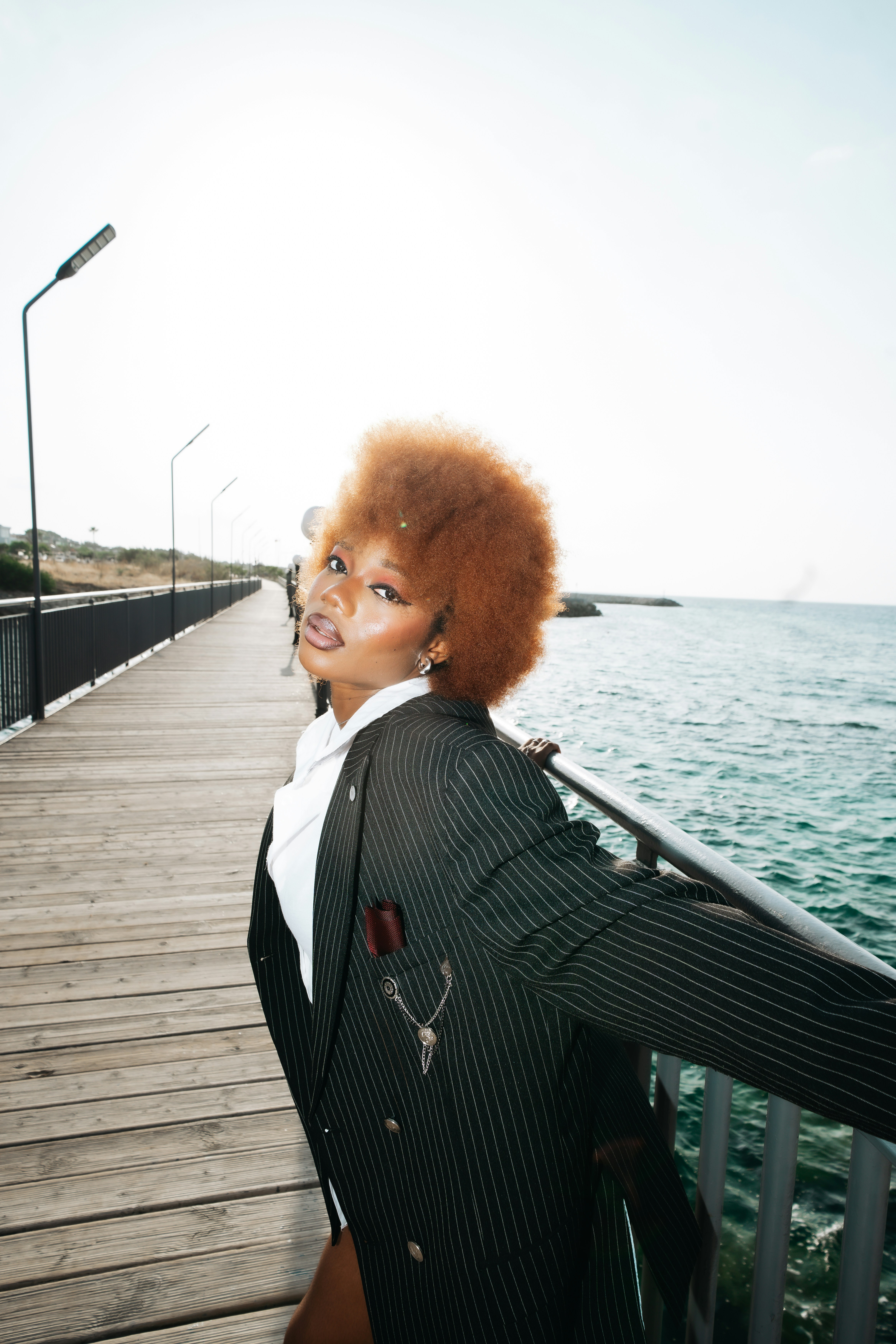 Portrait on the Pier: Confidence Amid Ocean Light