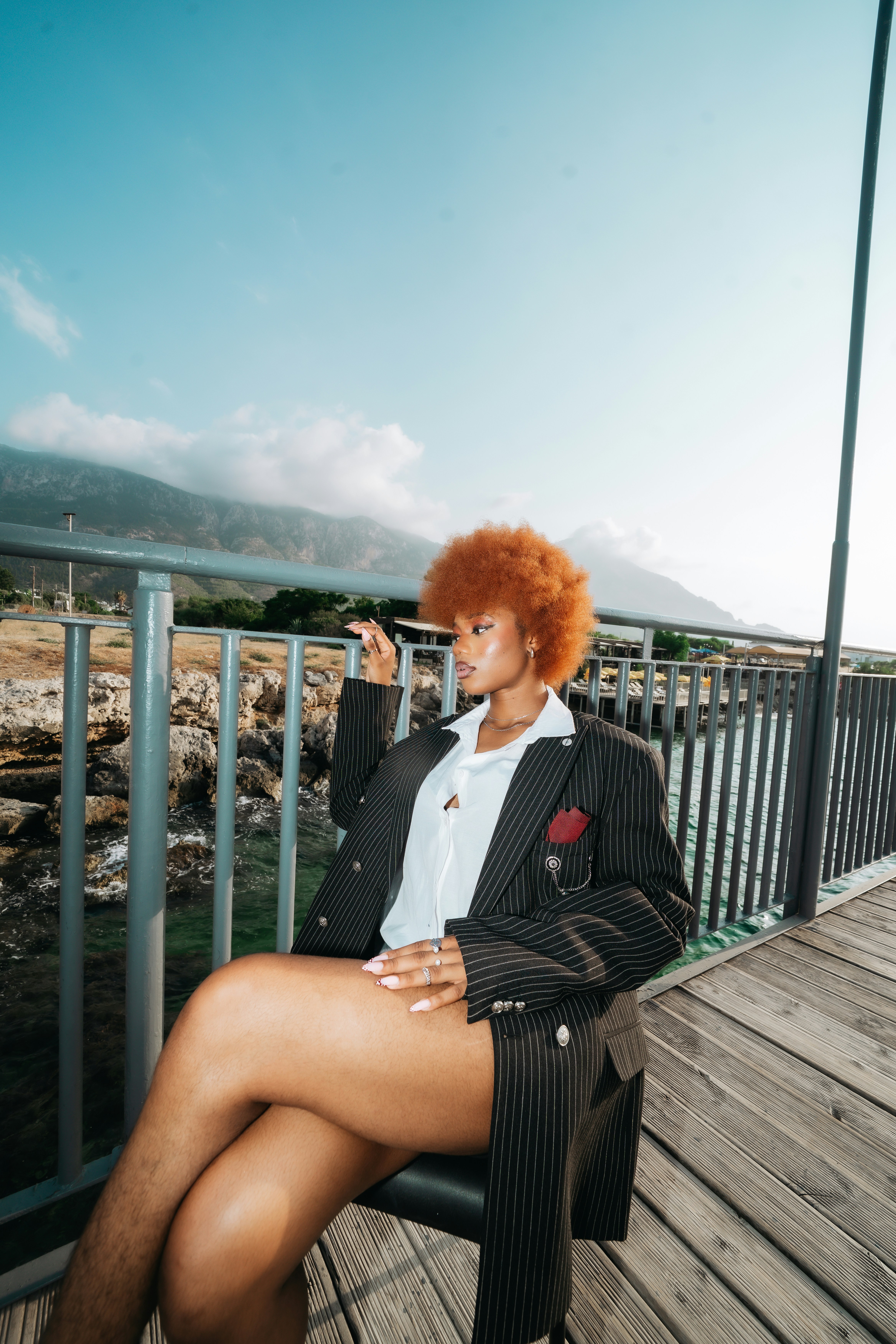 Powerful Pause on the Boardwalk: Sunset-Soft Portrait with an Afro-Top