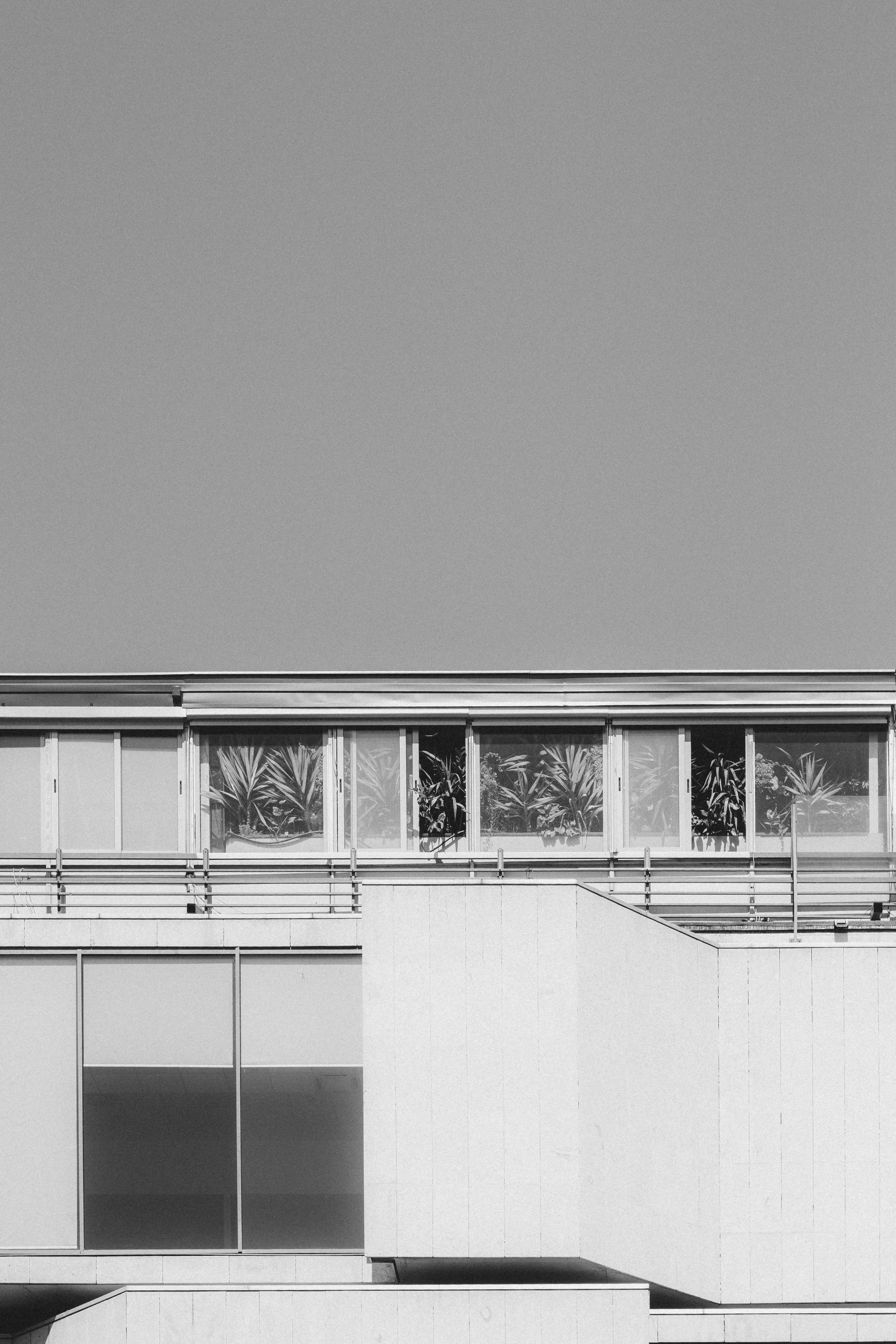 Monochrome Modern: Faceted Facade Above the White Balcony