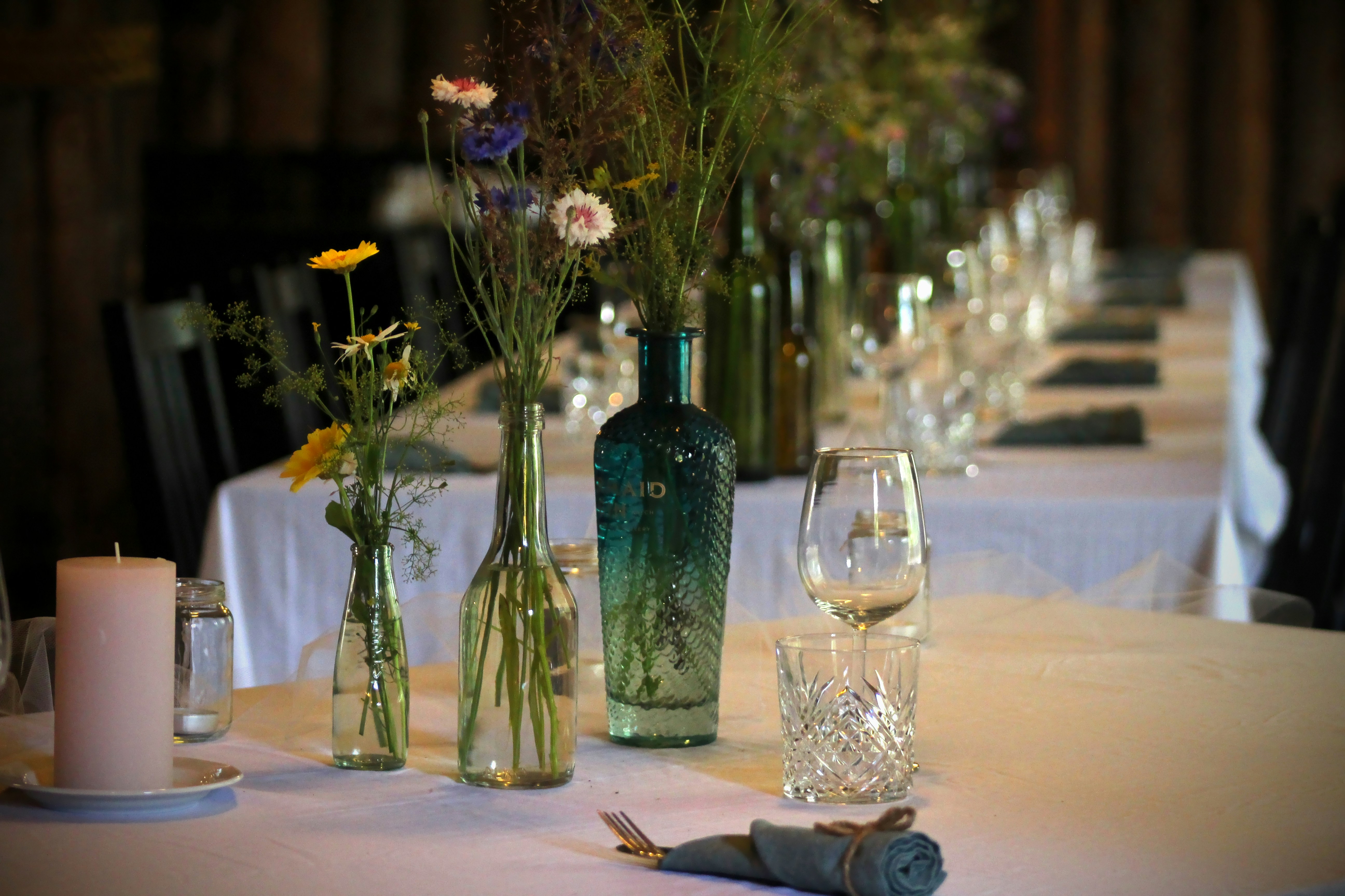 Centered Elegance: A Table of Glass Bottles and Soft Candlelight
