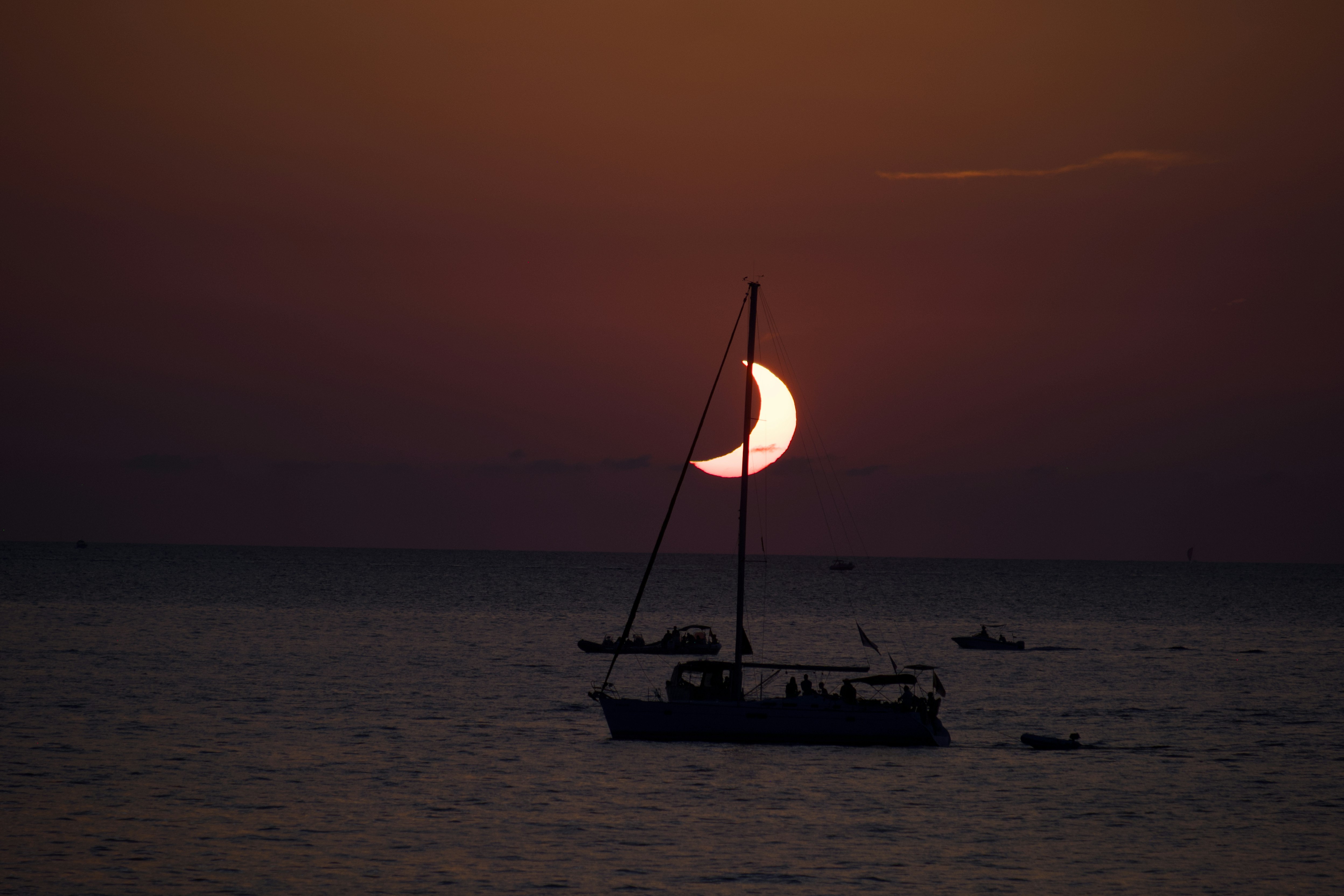 Sundown Sloop: Crescent Moon Glow Over Quiet Seas