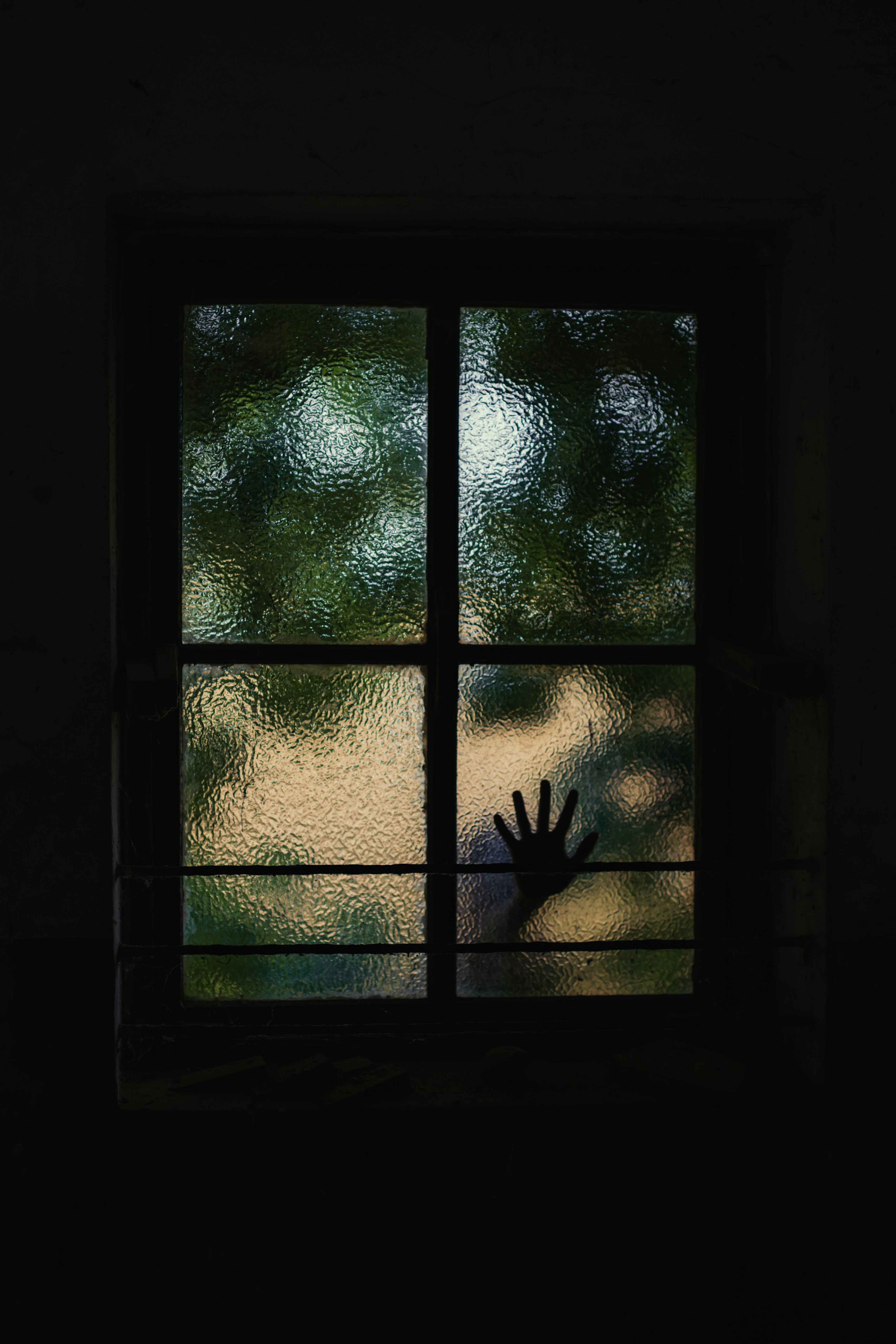 Silhouetted Hand on Translucent Window: A Quiet Boundary Between Shadow and Light