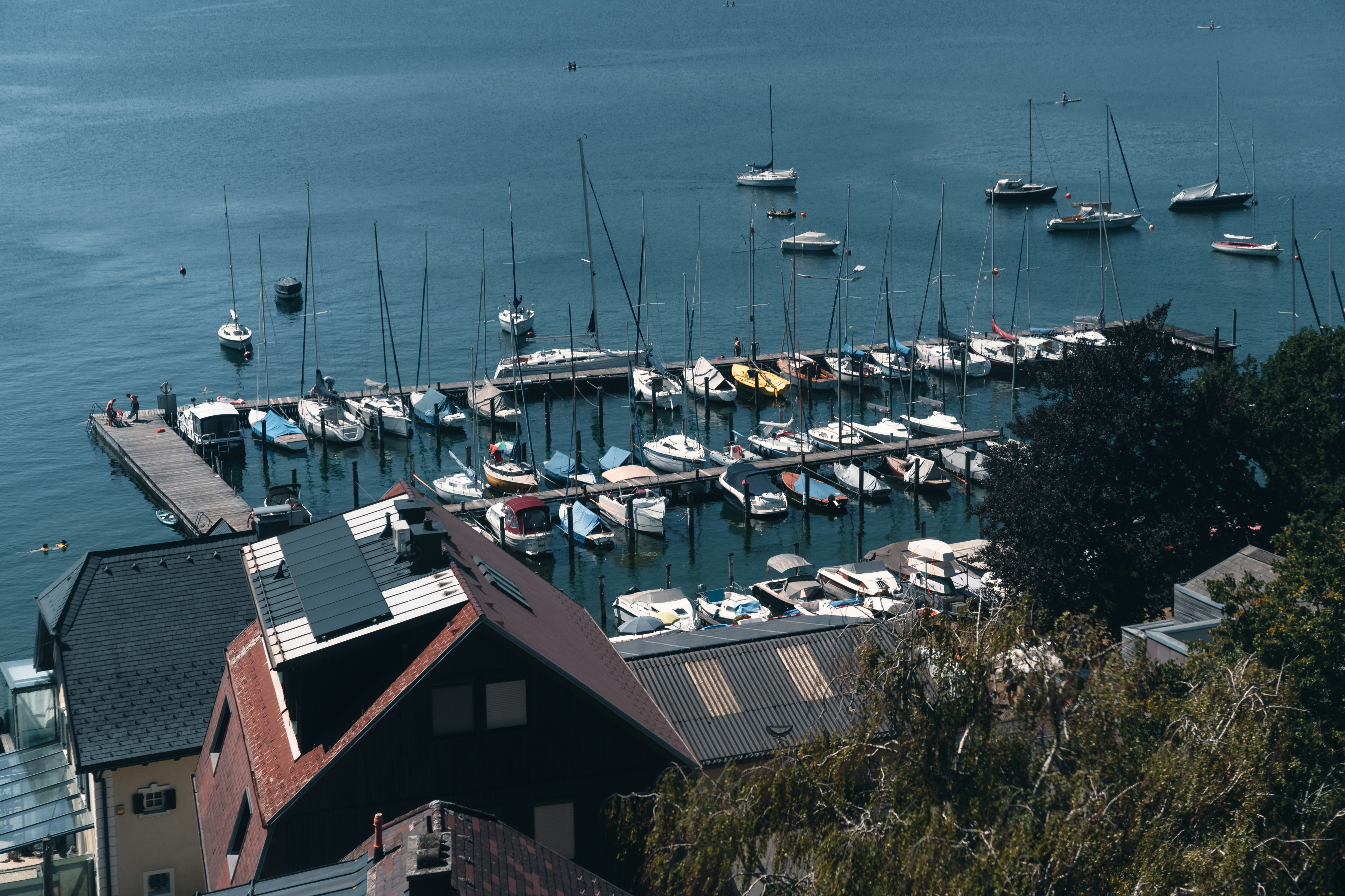 Harbor Mosaic: Boats, Docks, and a Red Rooftop Overlook