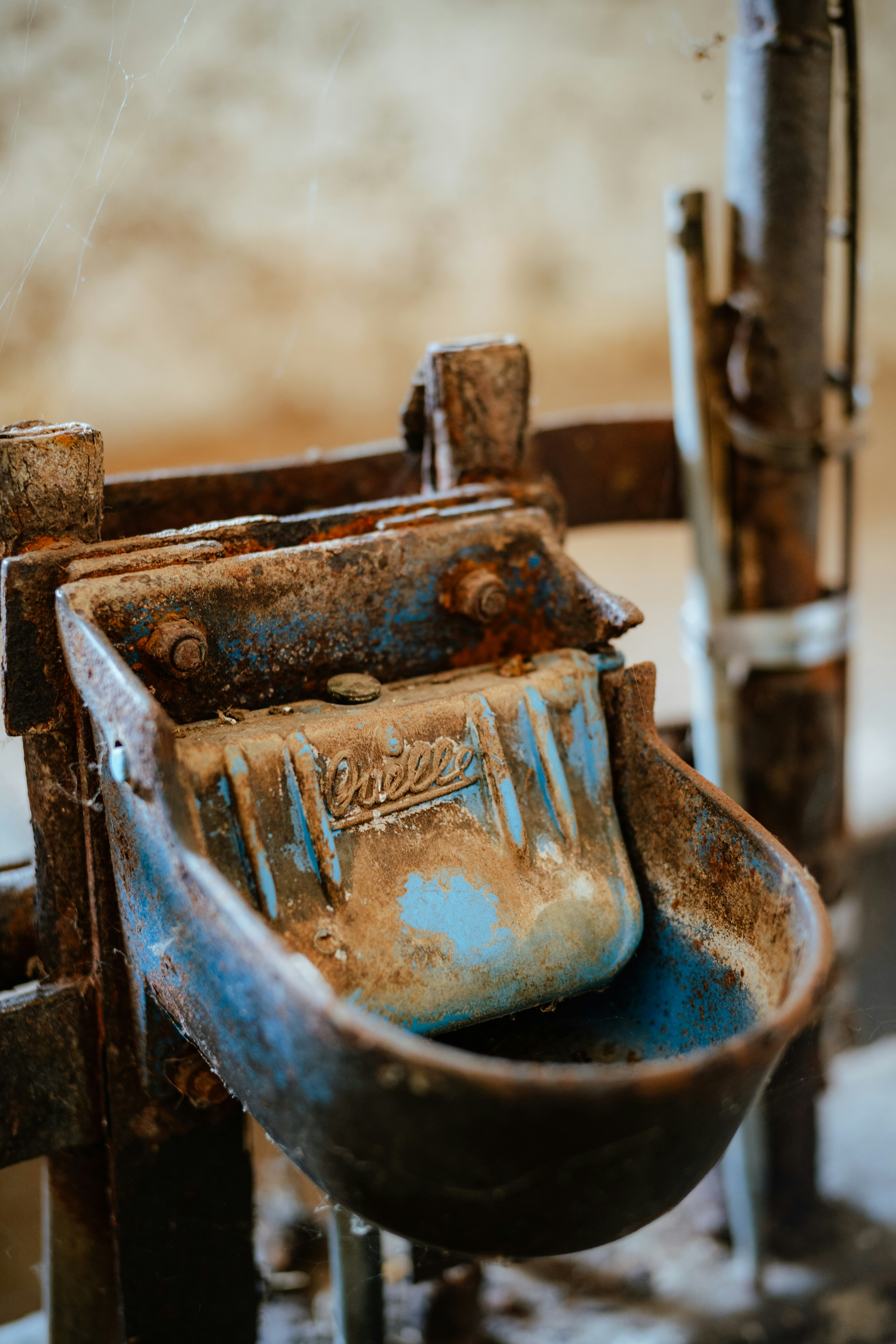 Aged Farm Implement in Faded Blue: Patina of Time on Rusted Machinery
