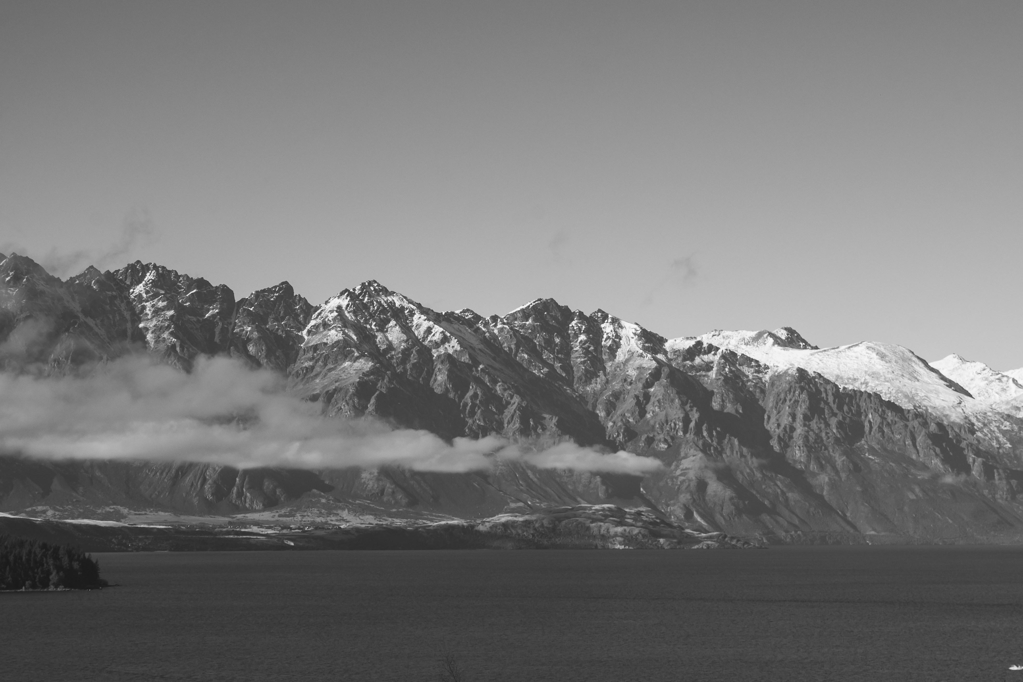 Snow-kissed Peaks Over a Quiet Fjord