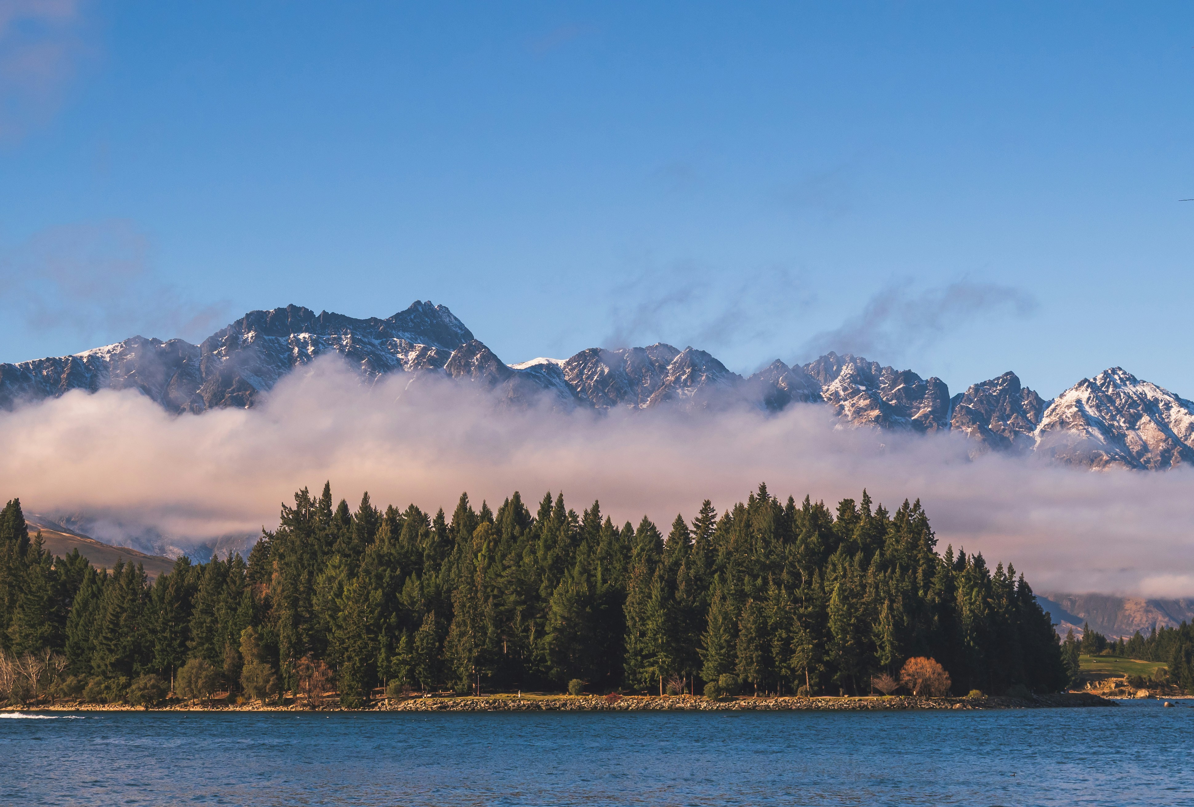 Misty Alpine Crest Over a Calm Lake