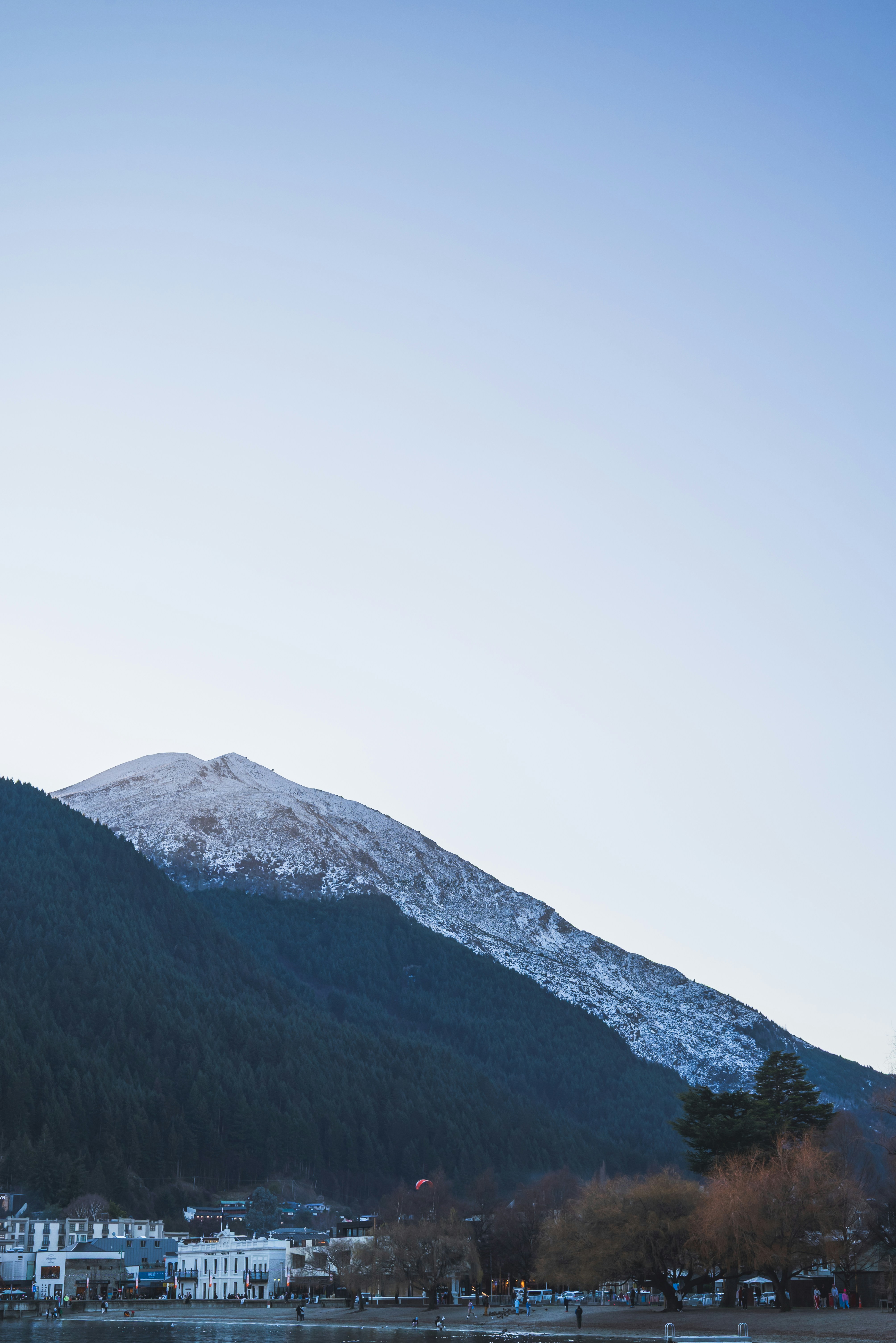Snow-Trimmed Peak Over a Quiet Lakeside Town
